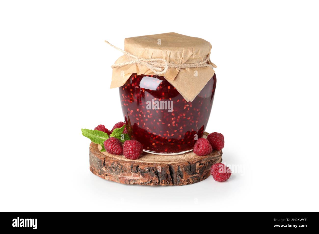 Jar of raspberry jam on a wooden stand, isolated on white background ...