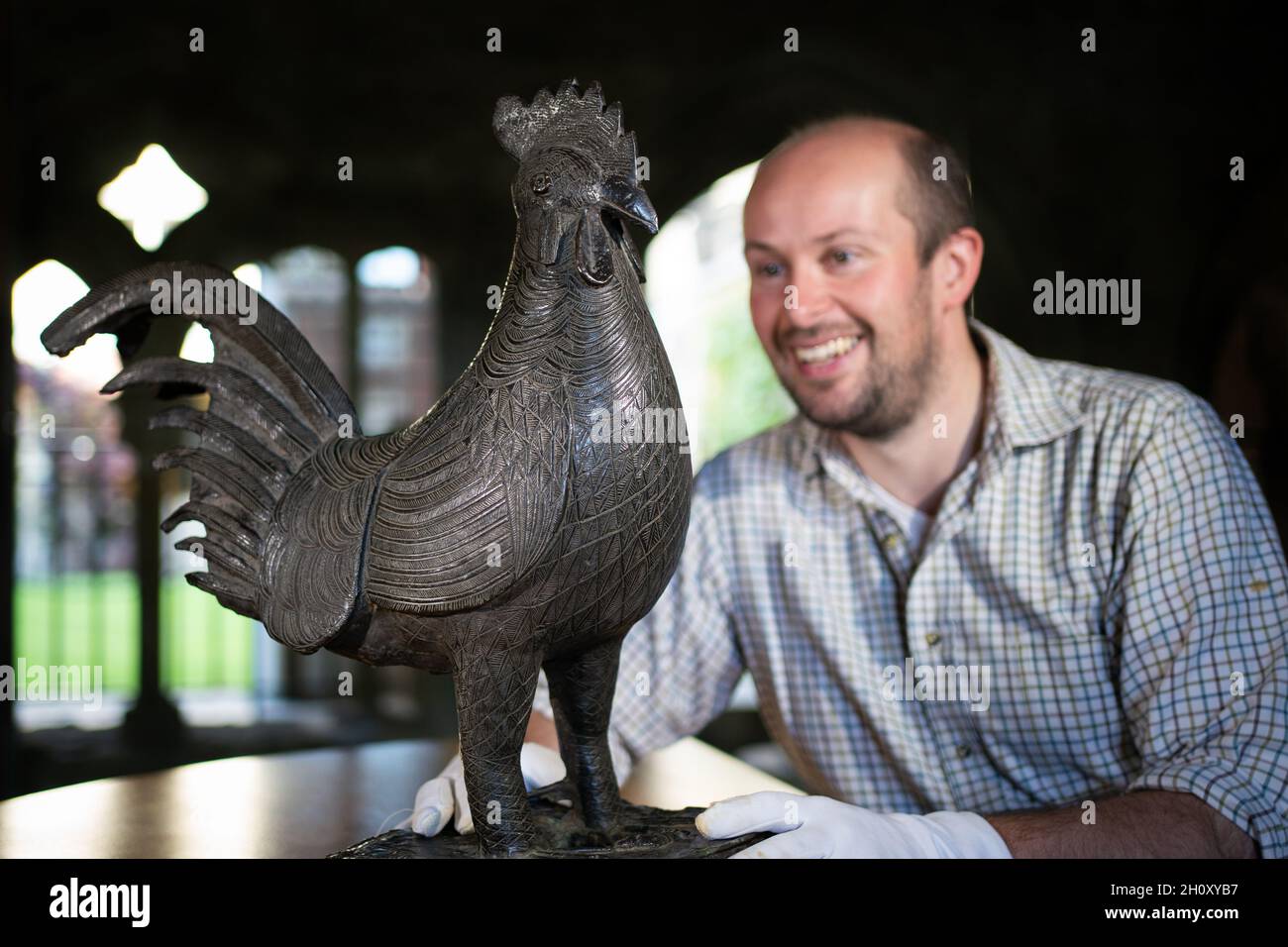 Archivist Robert Athol with a bronze statue of a cockerel called The ...
