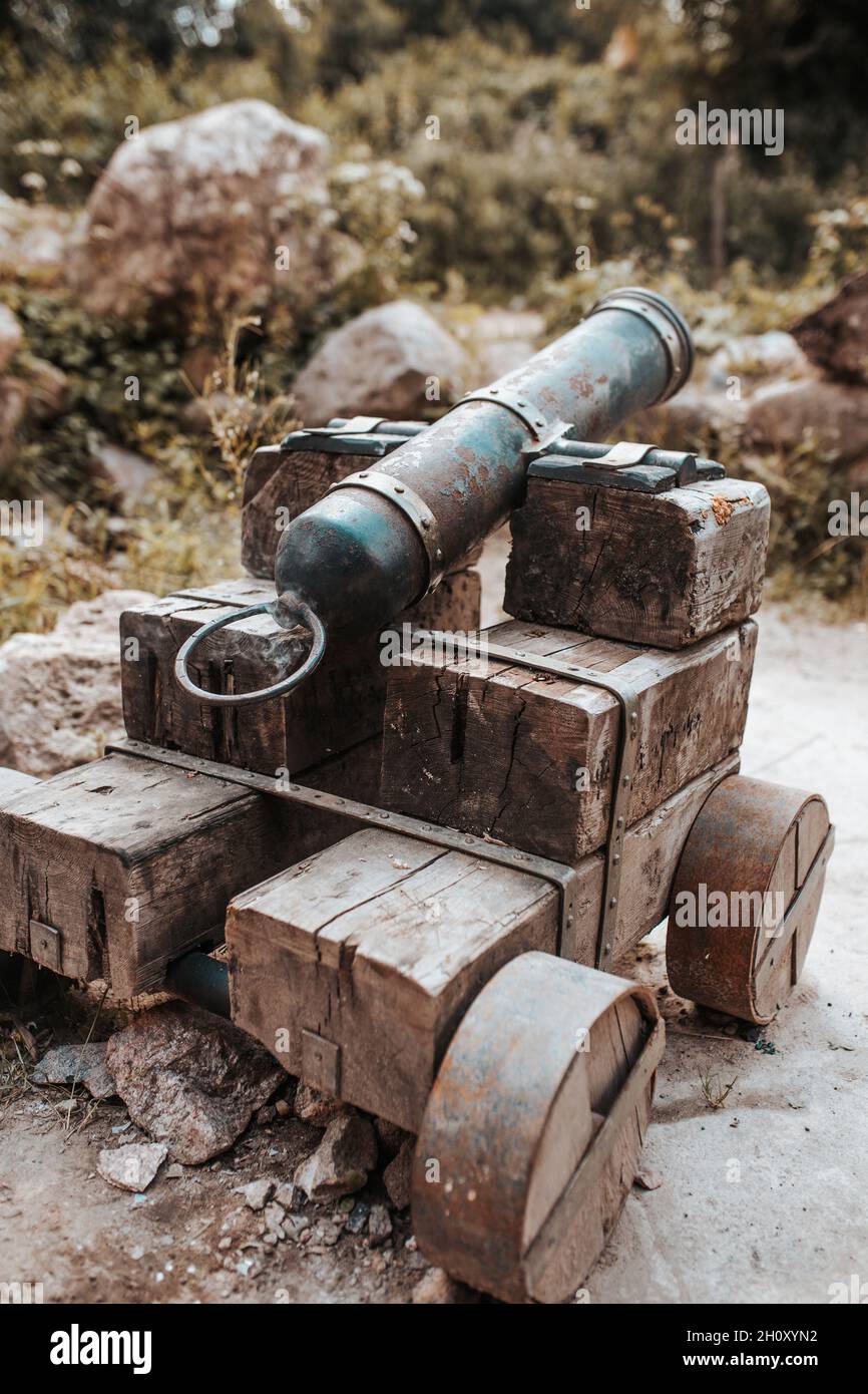 An old fashioned cannon with a wooden carriage and a cast iron barrel ...