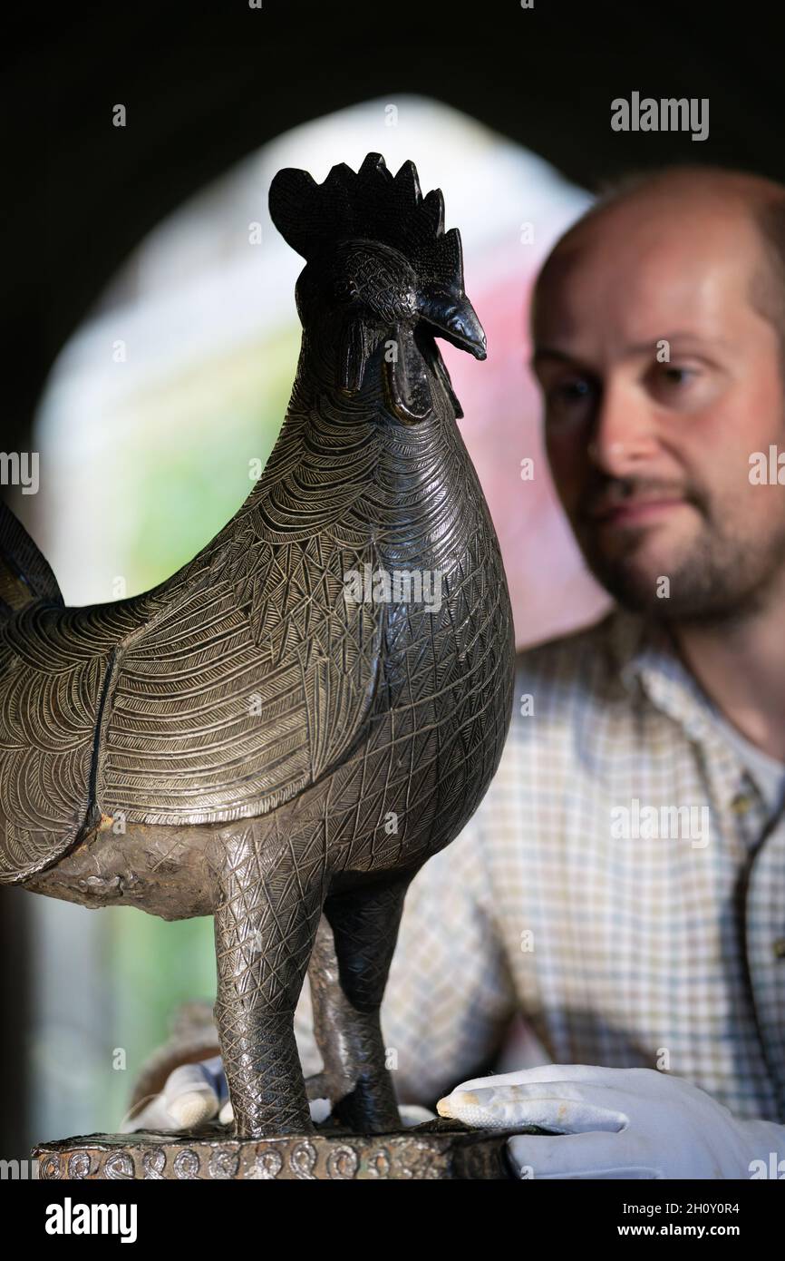 Archivist Robert Athol with a bronze statue of a cockerel called The ...