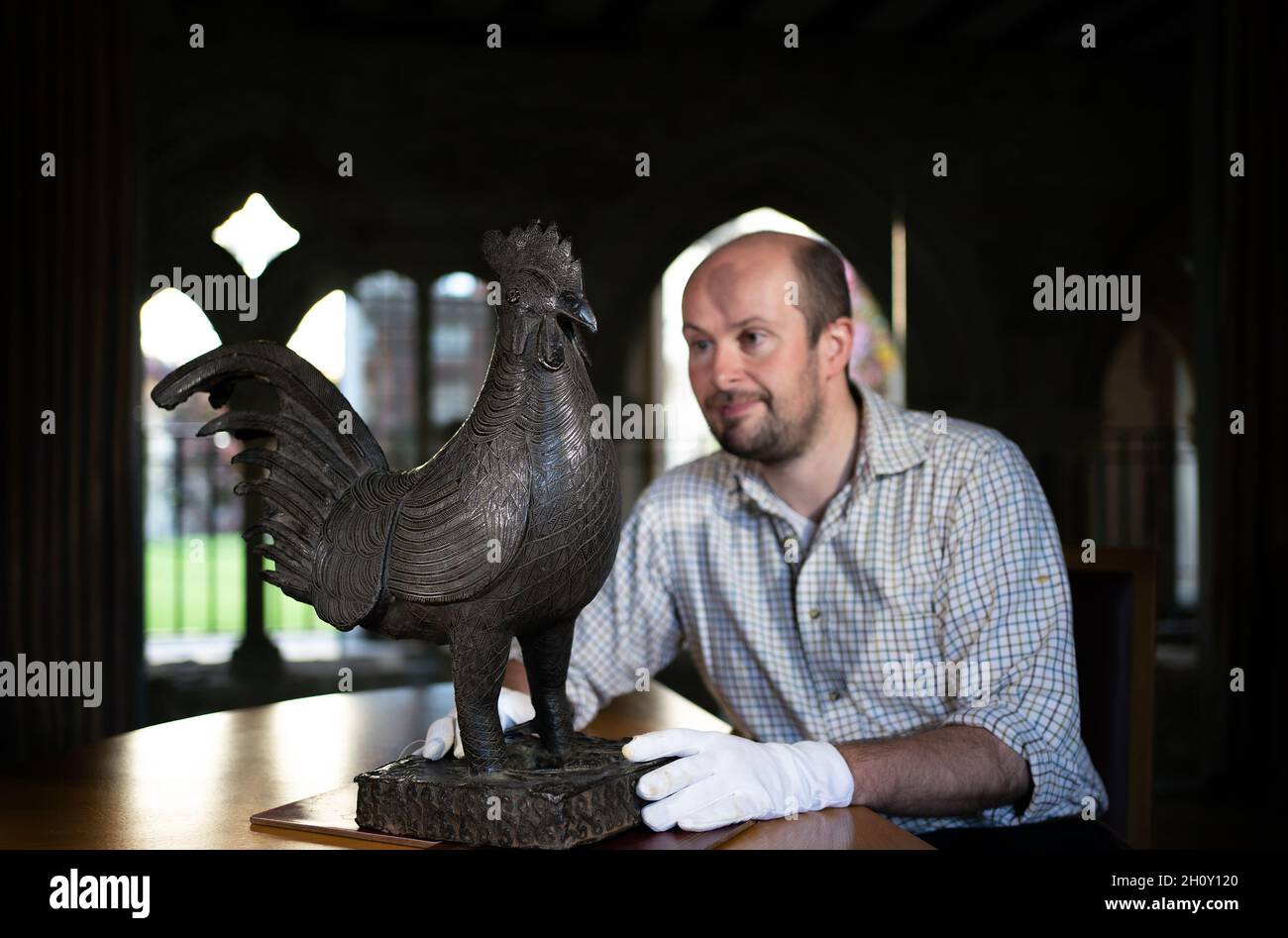 Archivist Robert Athol with a bronze statue of a cockerel called The ...