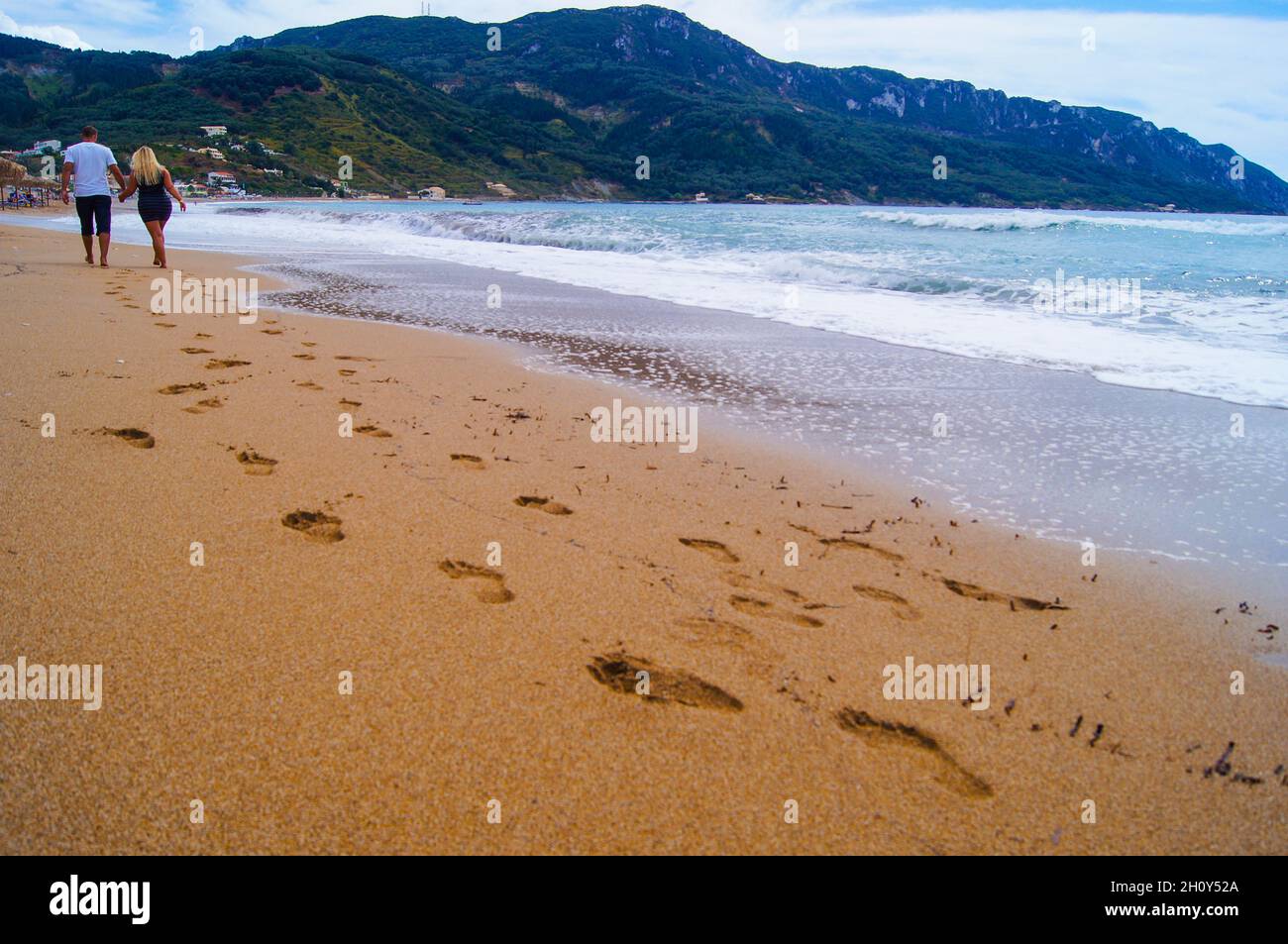 Couple leaving footprints beach hi-res stock photography and images - Alamy
