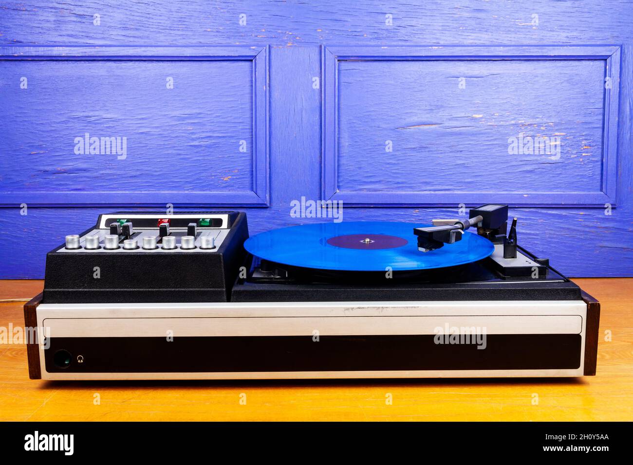 Vintage turntable vinyl record player with blue vinyl on a table Stock ...