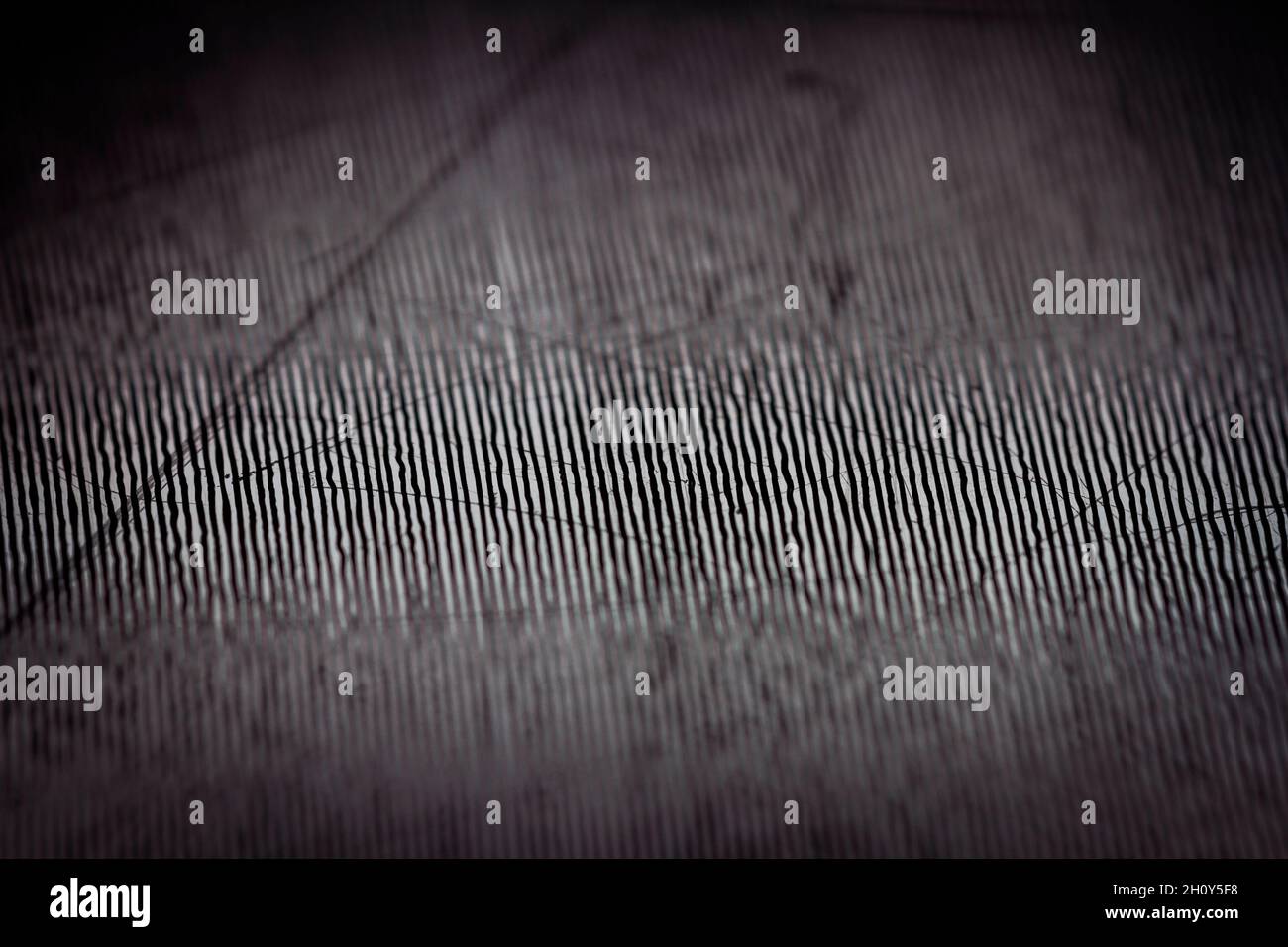 Macro shot of black vinyl record showing scratches. Surface of an old ...