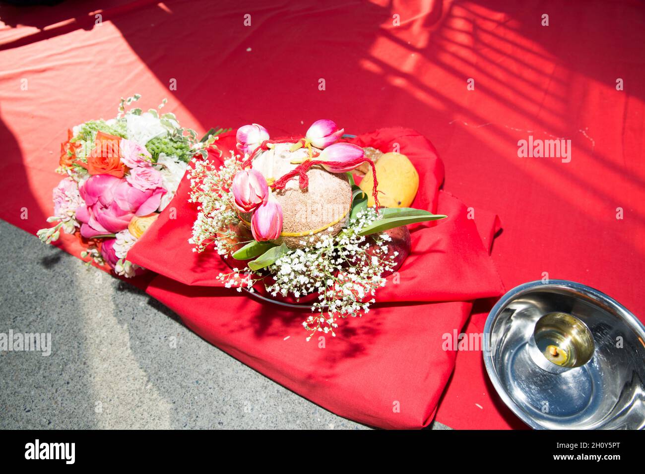 Closeup of the table with red tablecloth and decorations. Hindu wedding ...