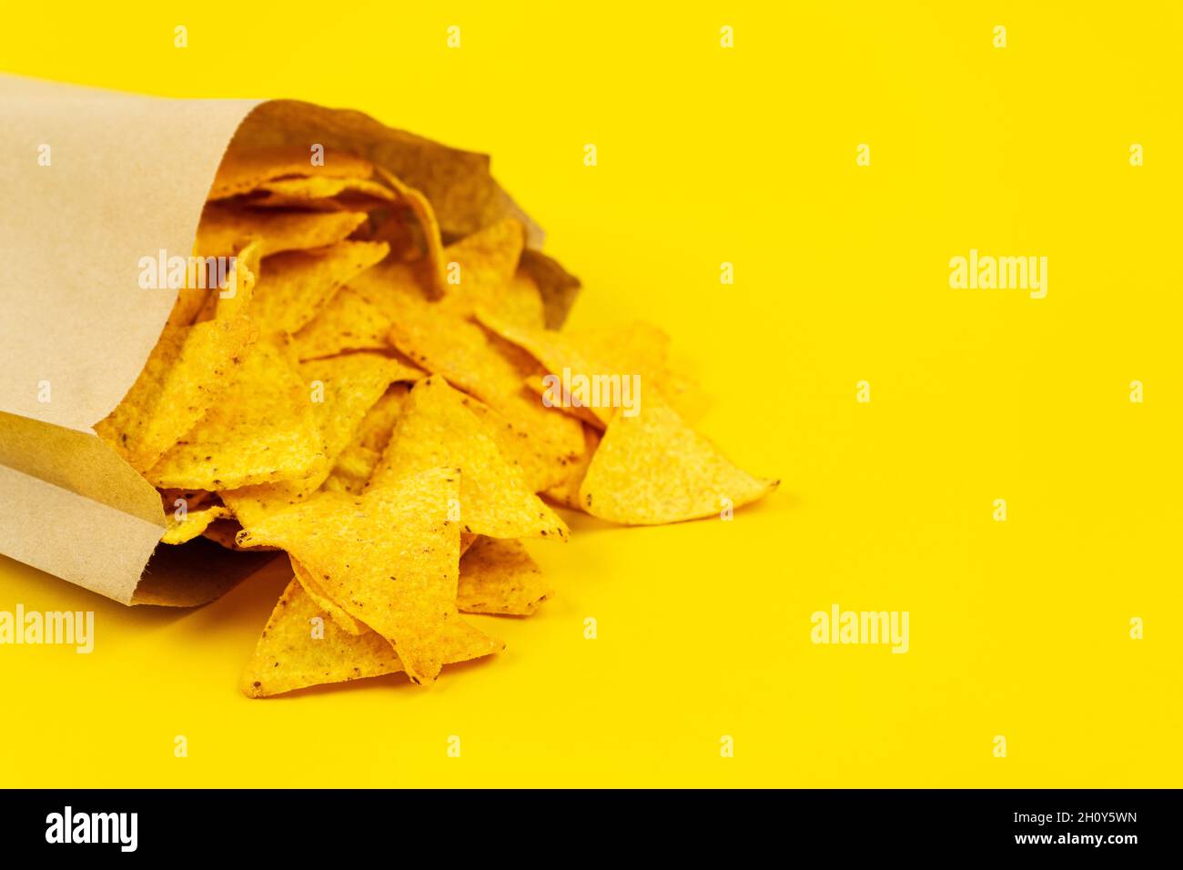 Crispy nachos chips in paper bag for convenience Stock Photo - Alamy