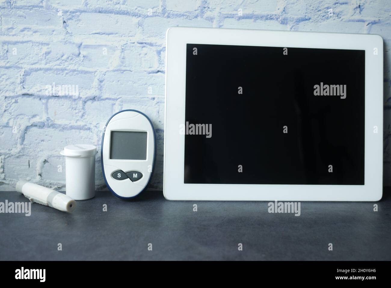 top view of digital tablet and diabetic measurement tool on table Stock ...