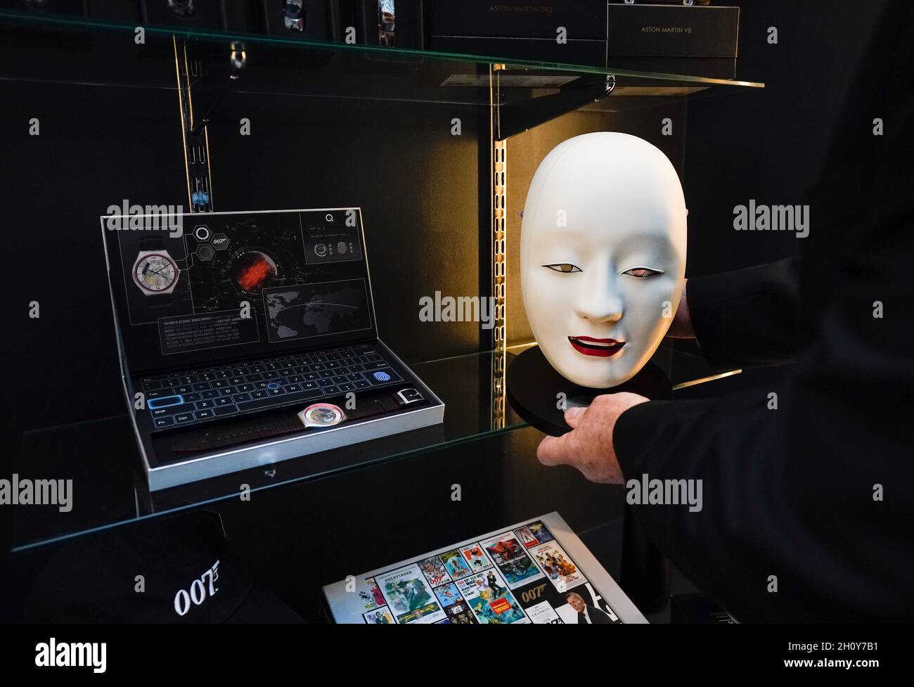 A person places a replica of the Safin mask into a display cabinet at ...