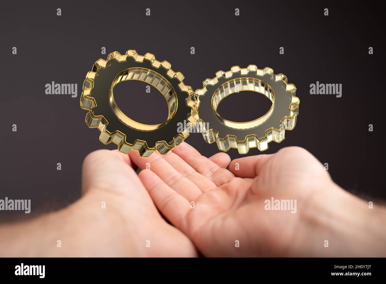 3D rendering of digital gears with hand touching it from behind ...
