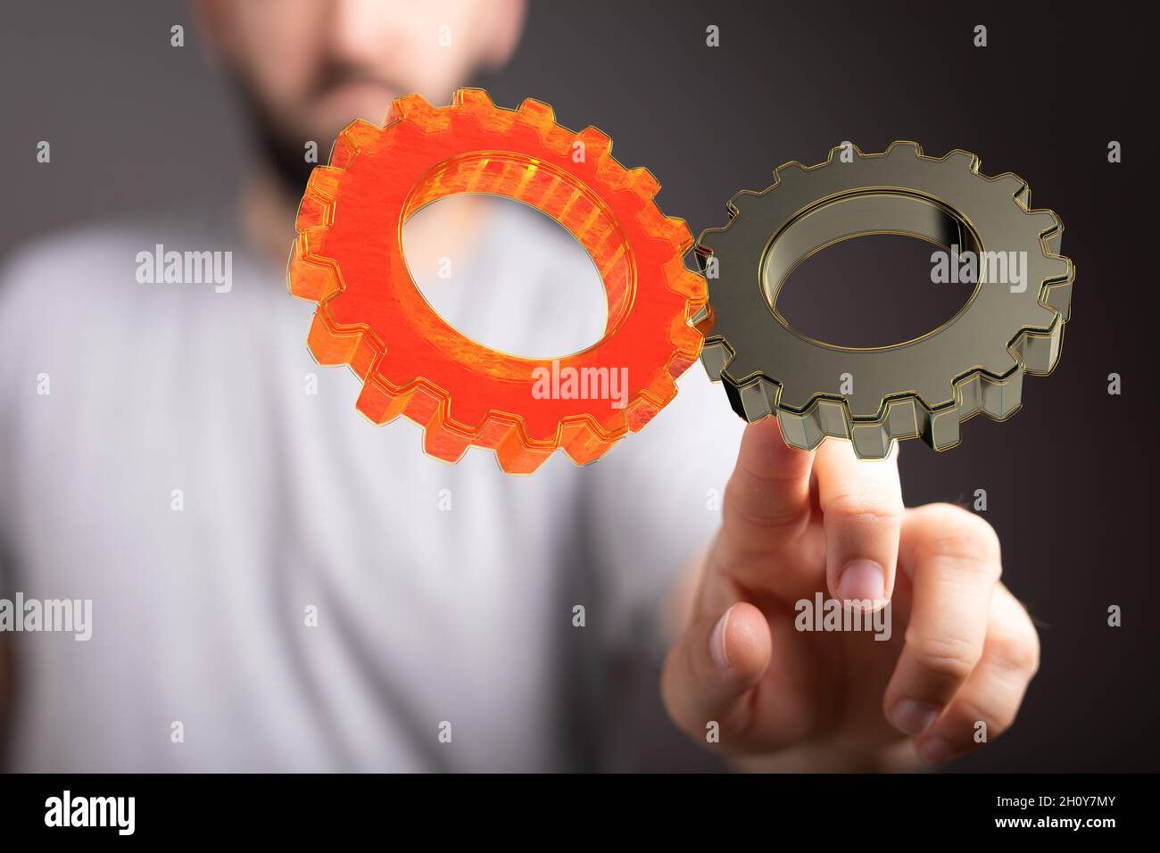 3D rendering of digital gears with hand touching it from behind ...