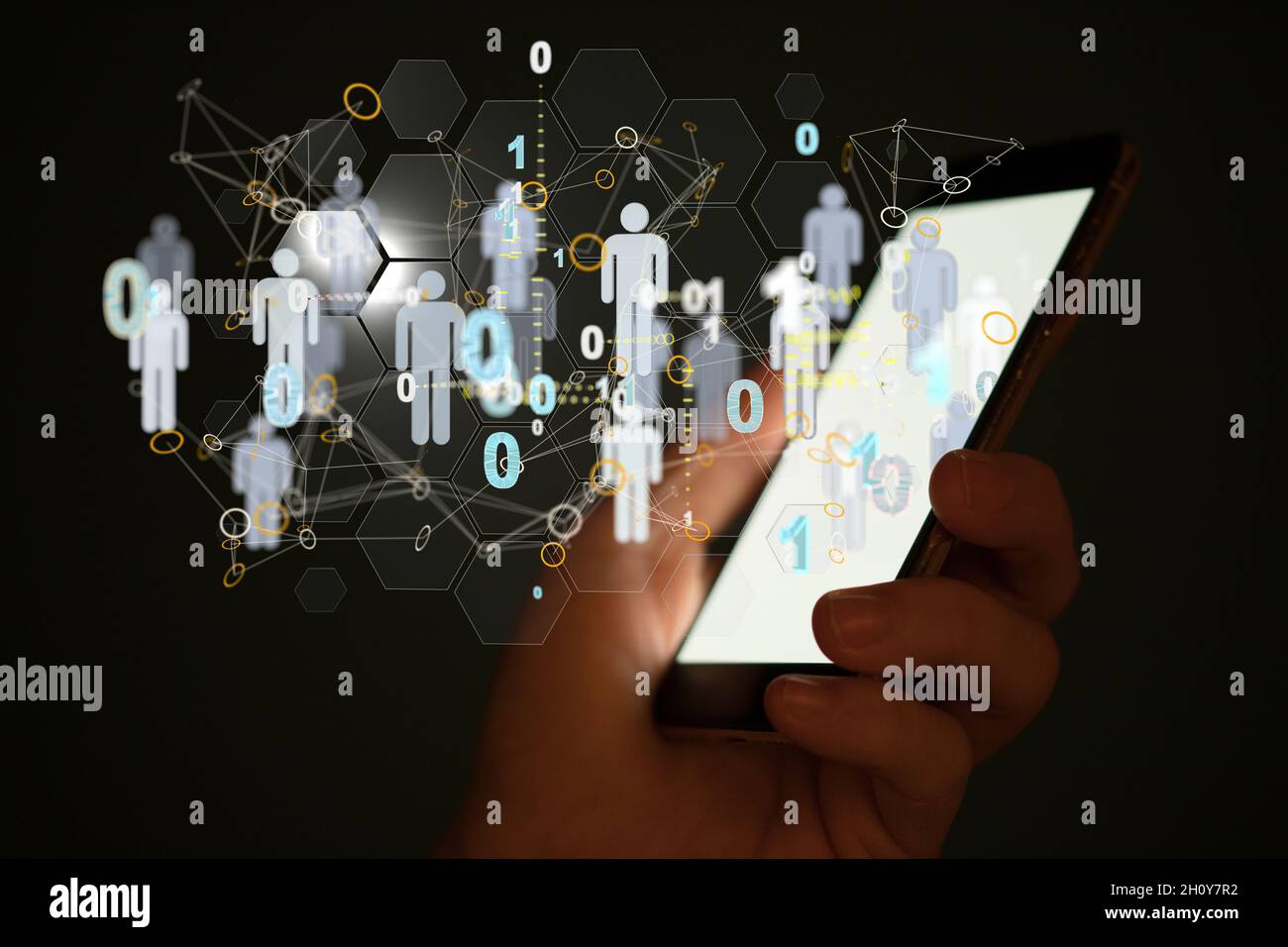 3D rendering of human icons with binary codes floating outside a hand holding phone Stock Photo ...