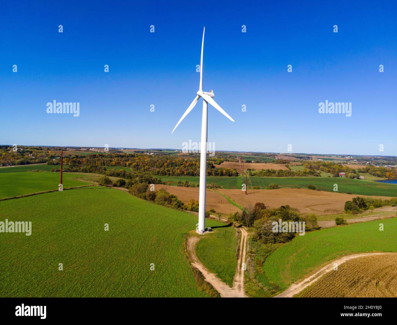 A wind turbine (windmill) generates electricity on a windy day in ...