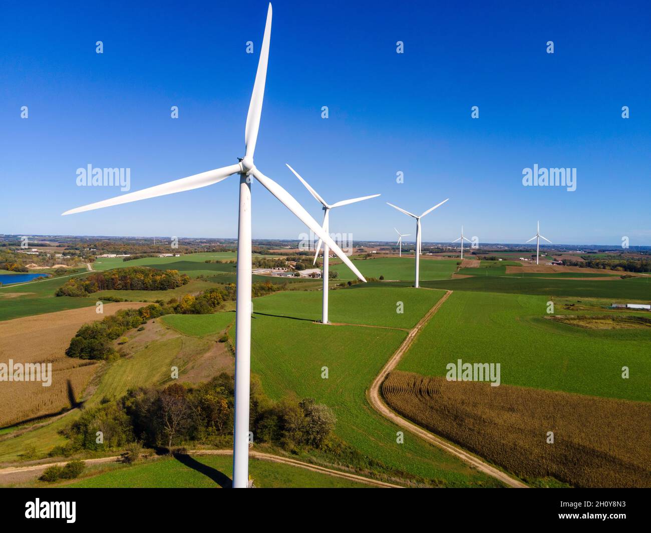 A wind turbine (windmill) generates electricity on a windy day in ...