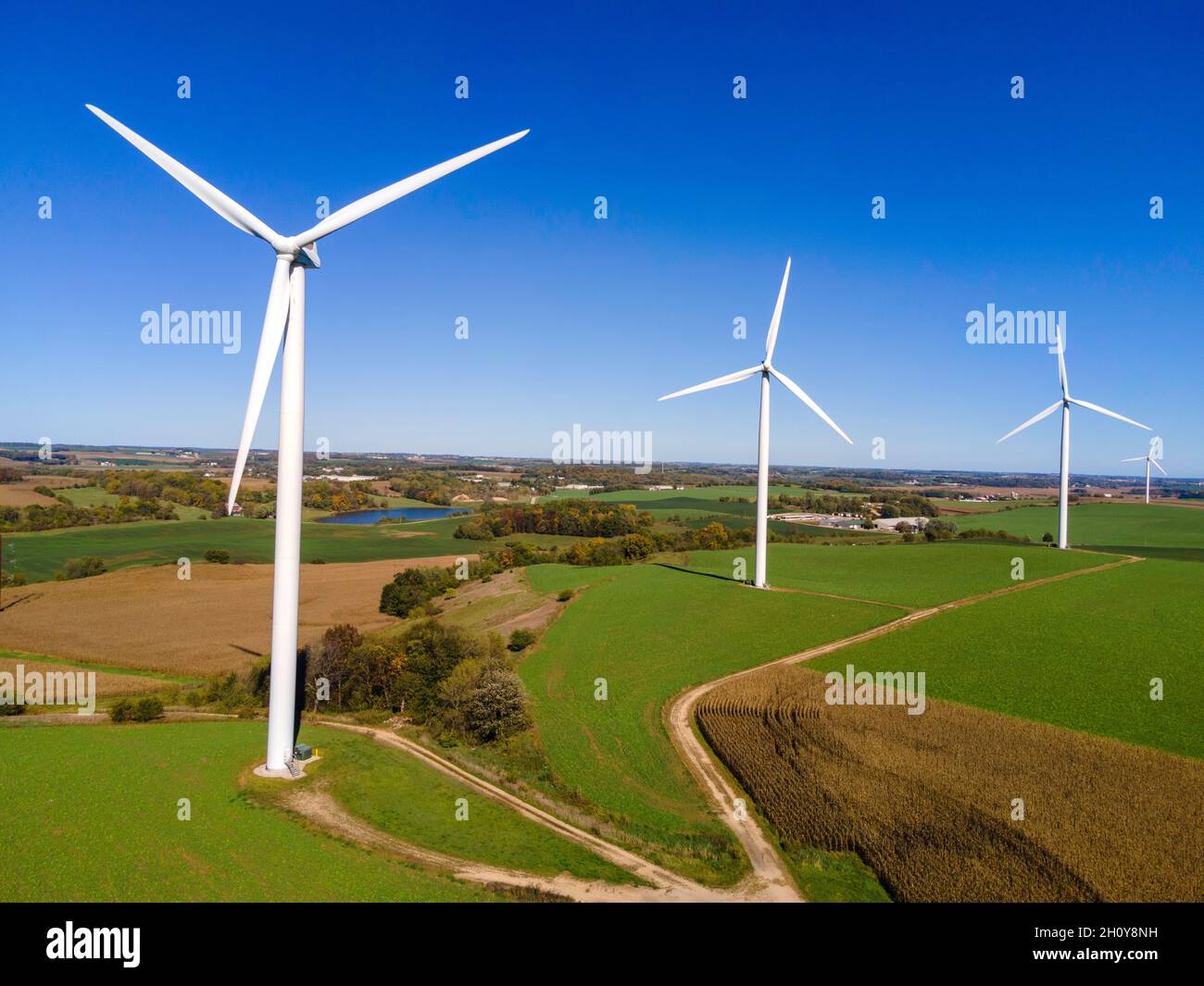 A wind turbine (windmill) generates electricity on a windy day in ...