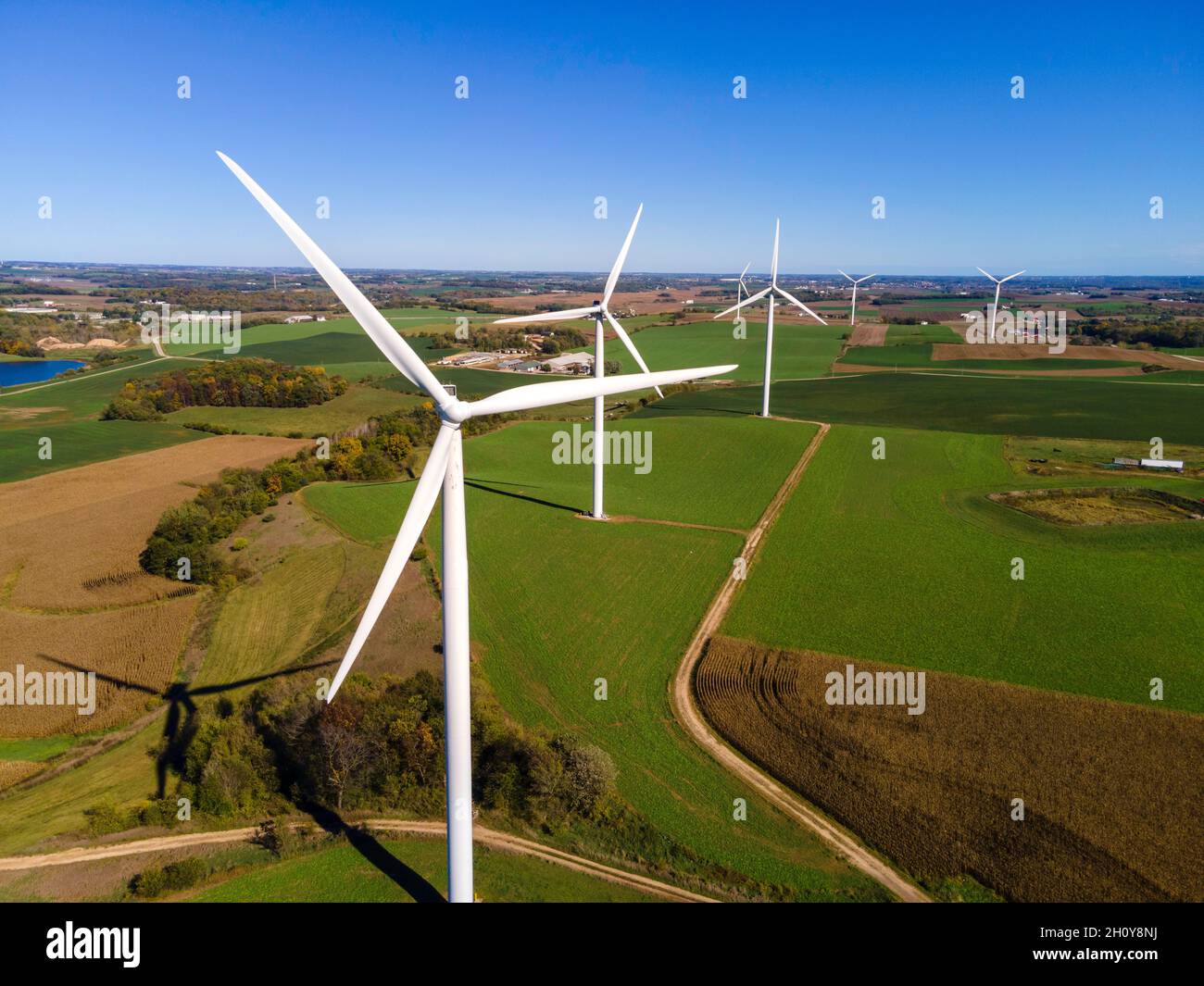 A wind turbine (windmill) generates electricity on a windy day in ...