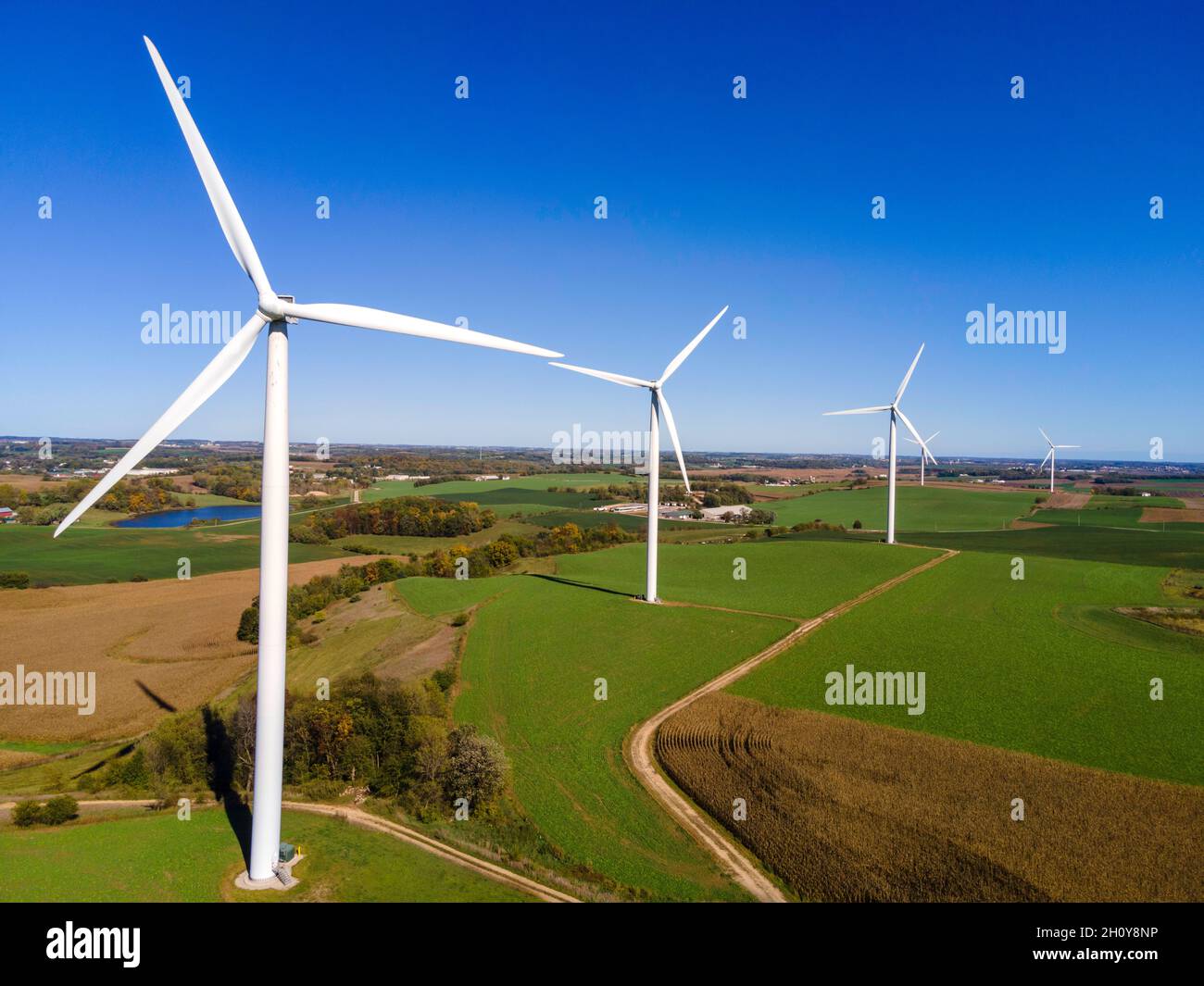 A wind turbine (windmill) generates electricity on a windy day in ...