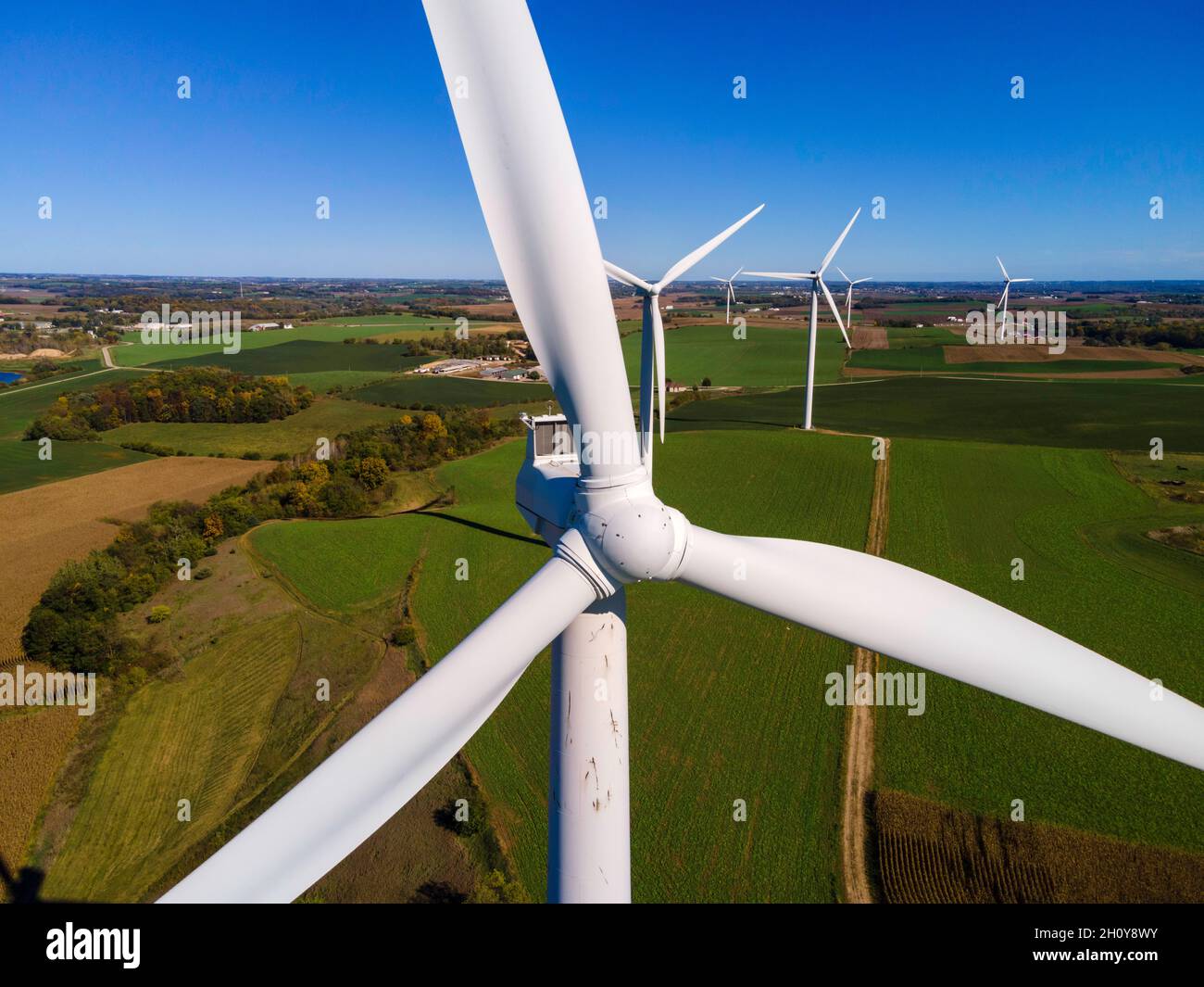 A wind turbine (windmill) generates electricity on a windy day in ...