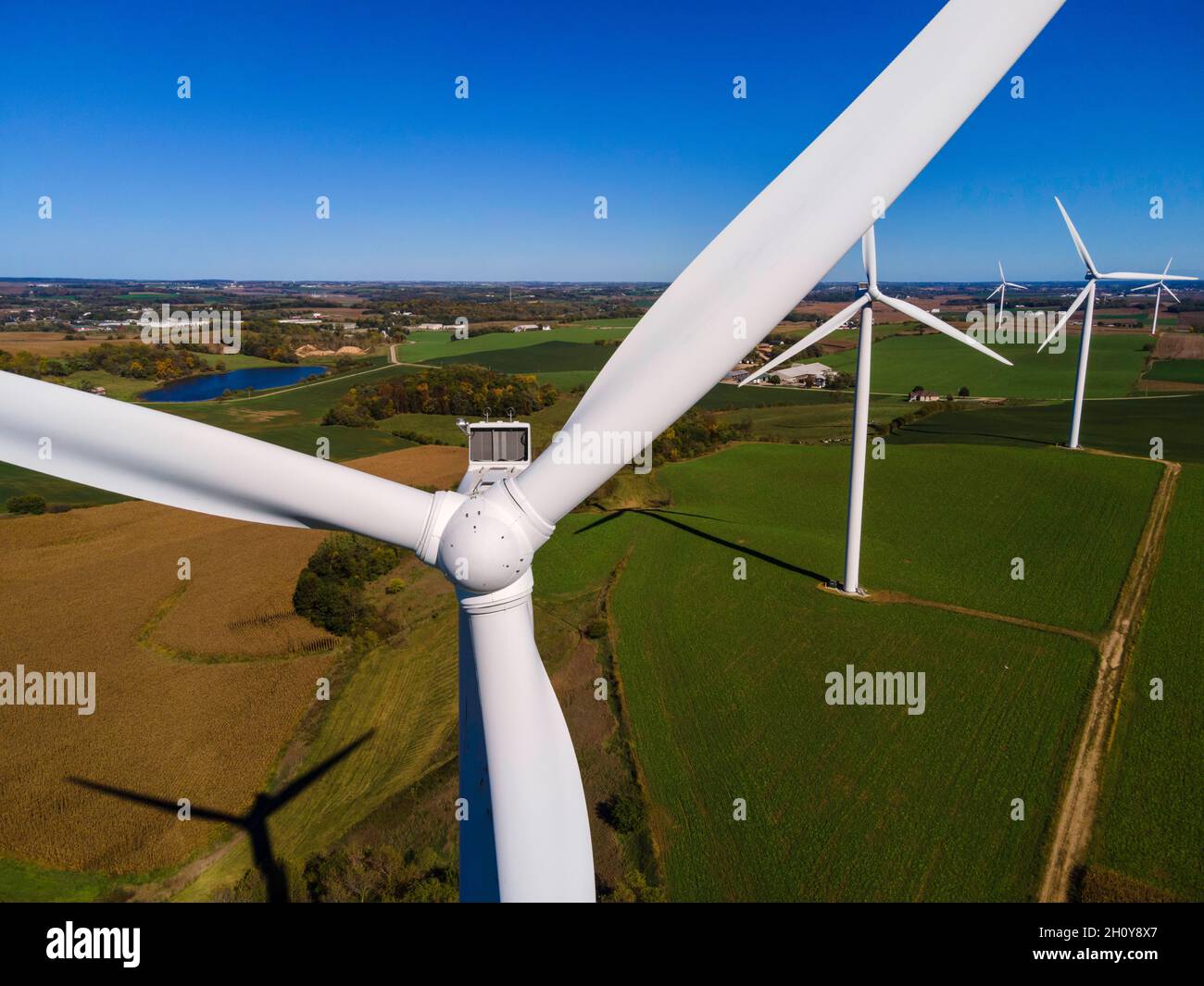 A wind turbine (windmill) generates electricity on a windy day in ...