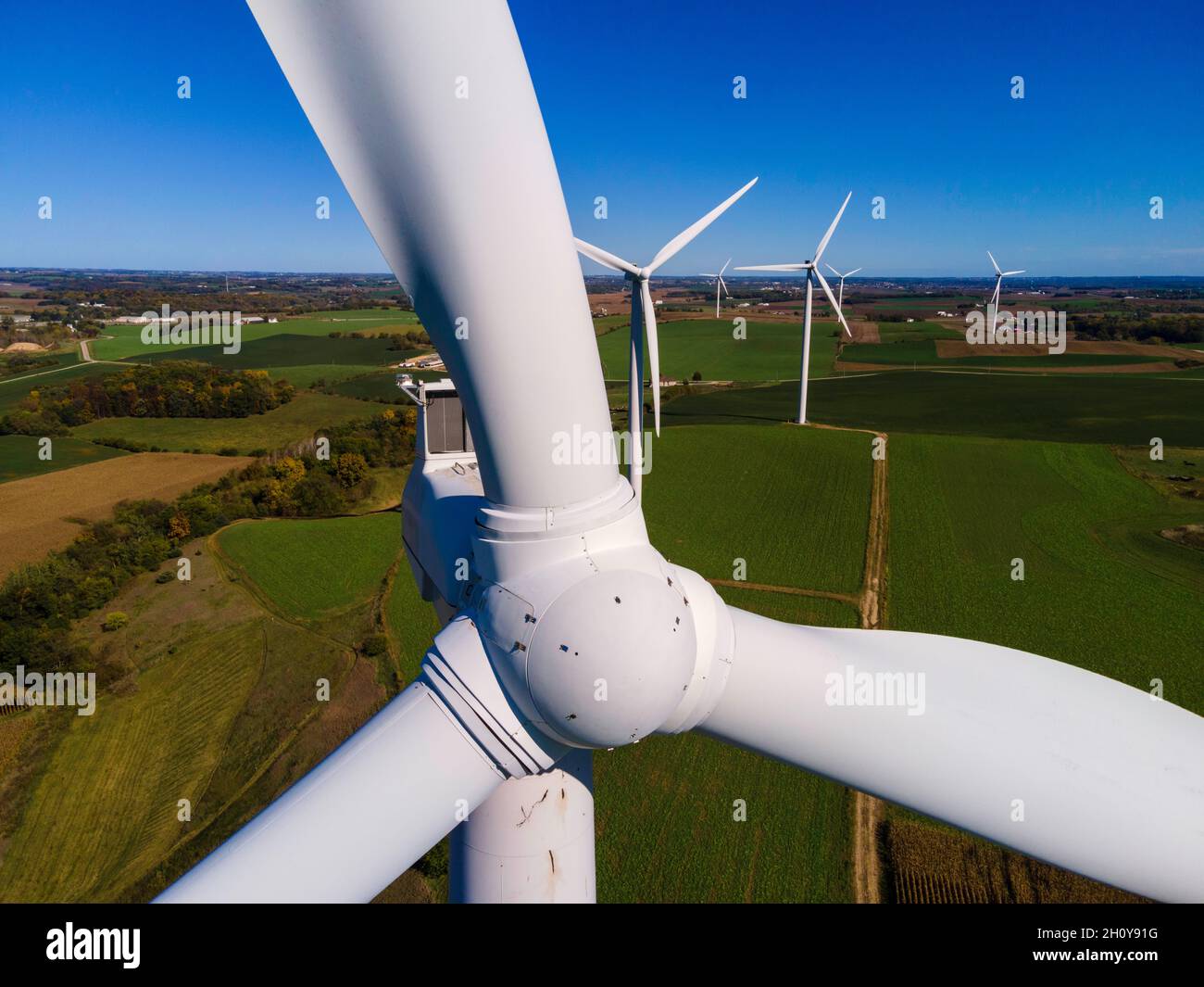 A wind turbine (windmill) generates electricity on a windy day in ...