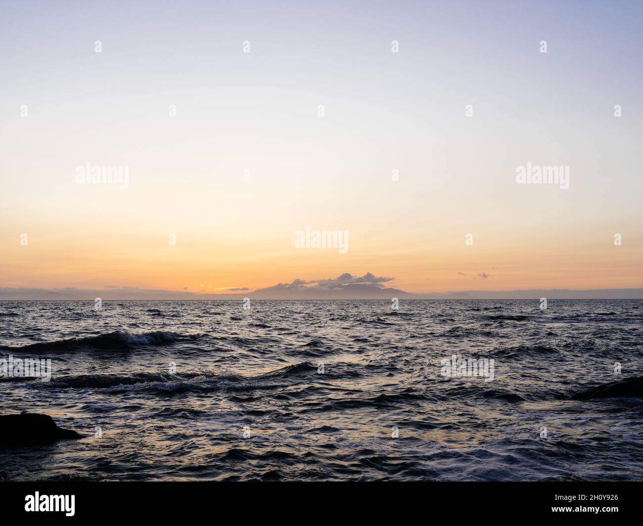 View at sunset of the Scottish Island of Arran across the sea from ...
