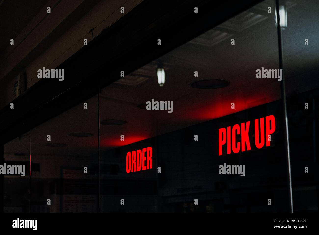 Red order and pick up signs hanging on the wall and glowing in the ...