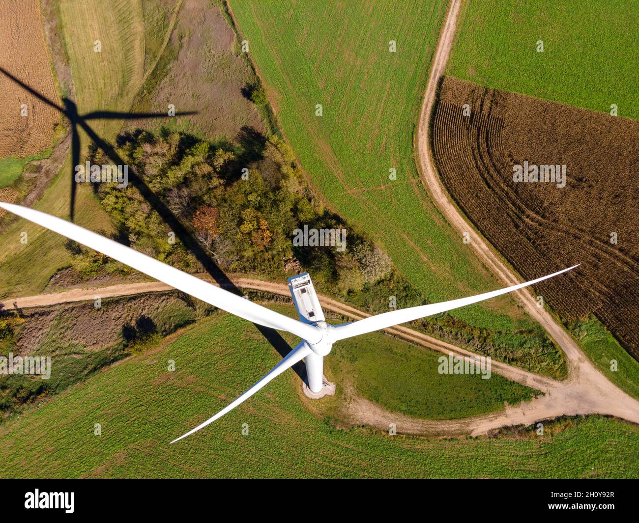 A wind turbine (windmill) generates electricity on a windy day in ...