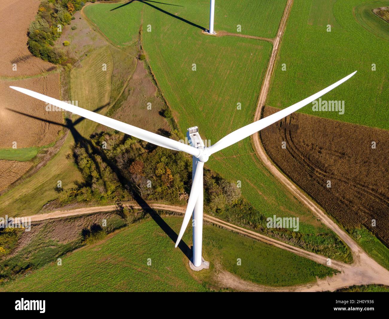 A wind turbine (windmill) generates electricity on a windy day in ...