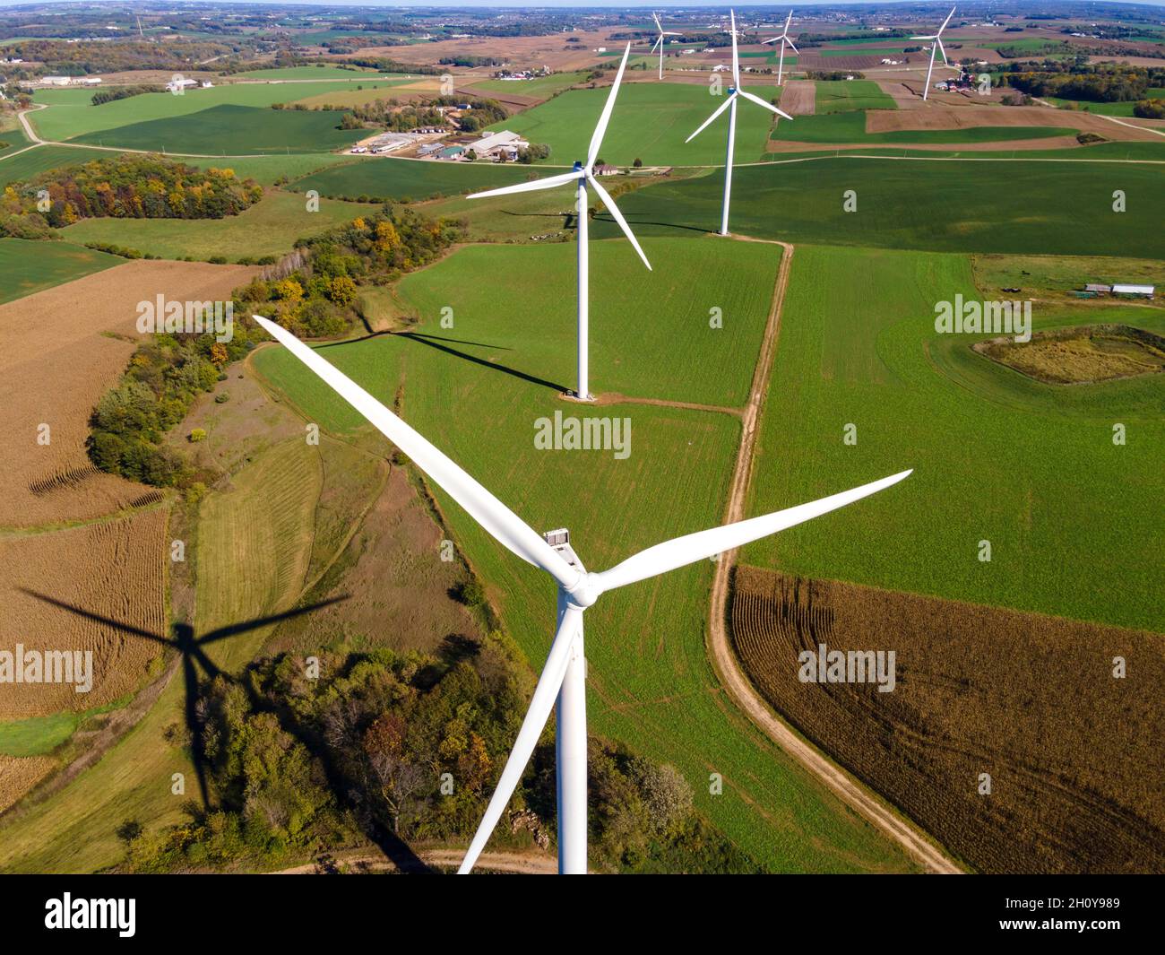 A wind turbine (windmill) generates electricity on a windy day in ...