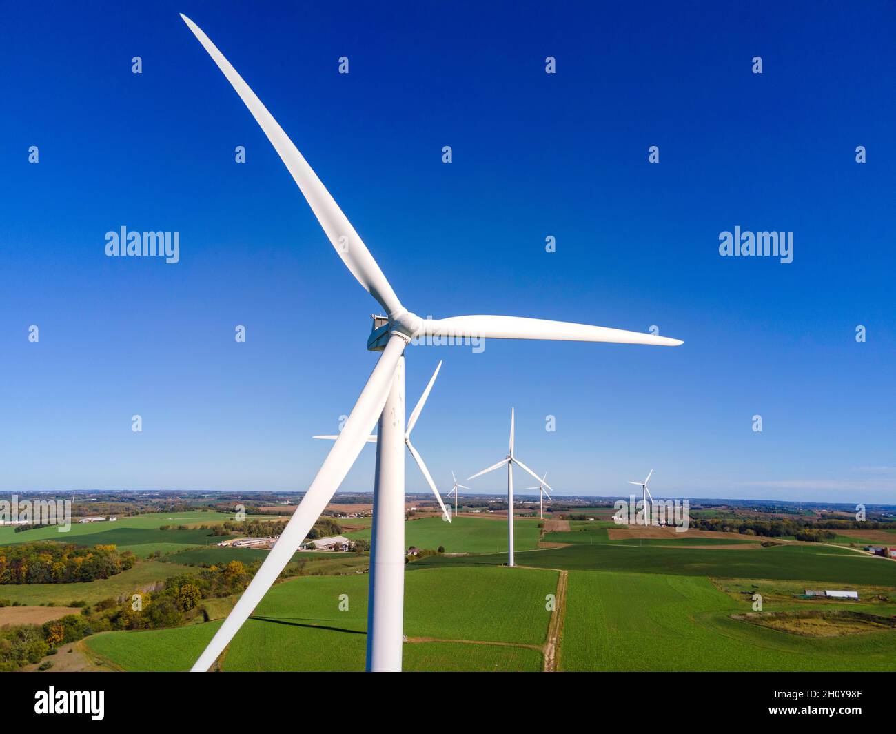 A wind turbine (windmill) generates electricity on a windy day in ...