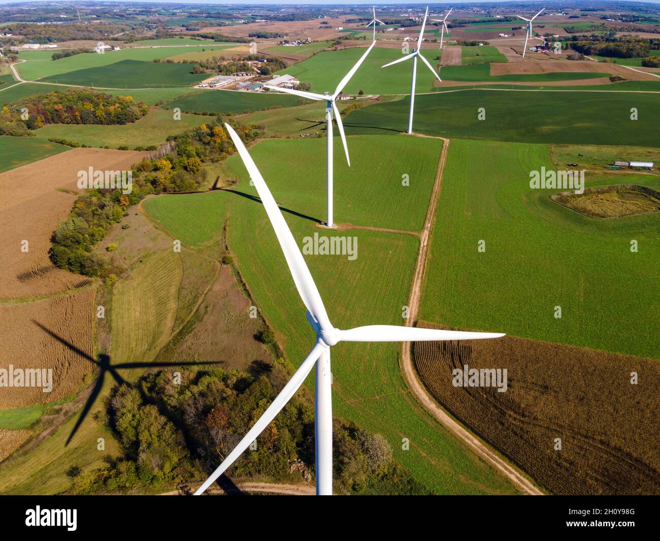 A wind turbine (windmill) generates electricity on a windy day in ...