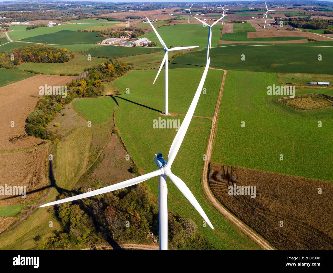 A wind turbine (windmill) generates electricity on a windy day in ...