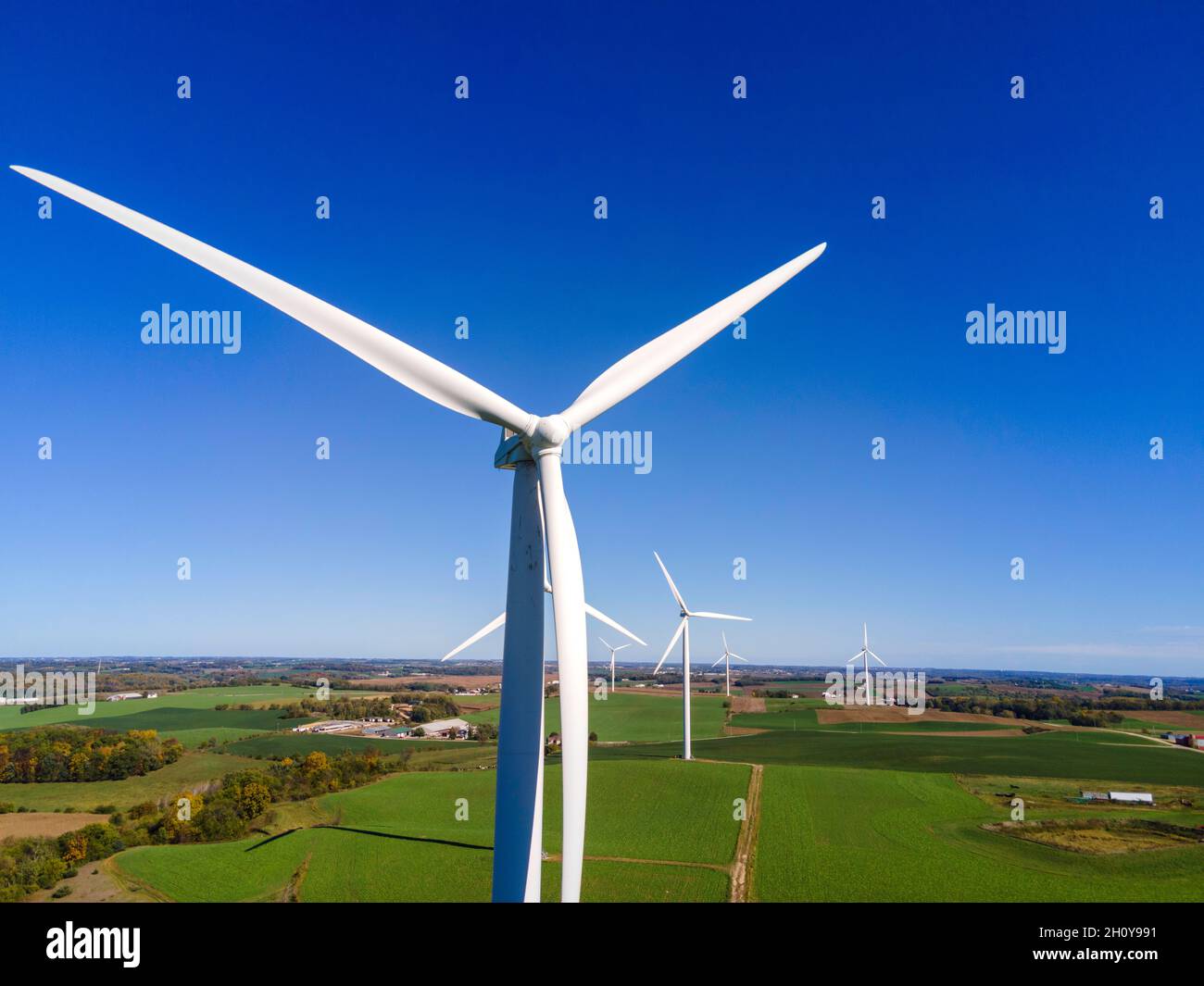 A wind turbine (windmill) generates electricity on a windy day in ...