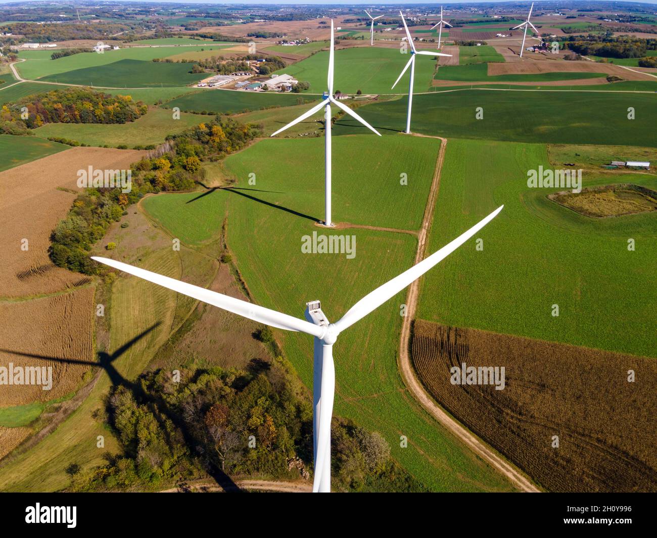 A wind turbine (windmill) generates electricity on a windy day in ...