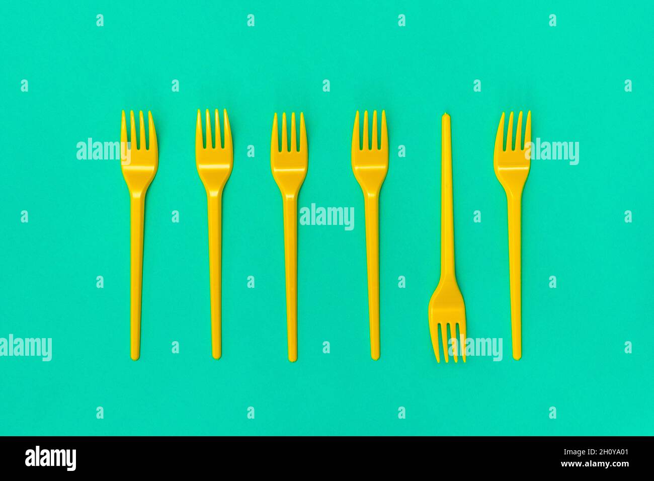 Yellow disposable forks lying on the blue background. Top view Stock ...