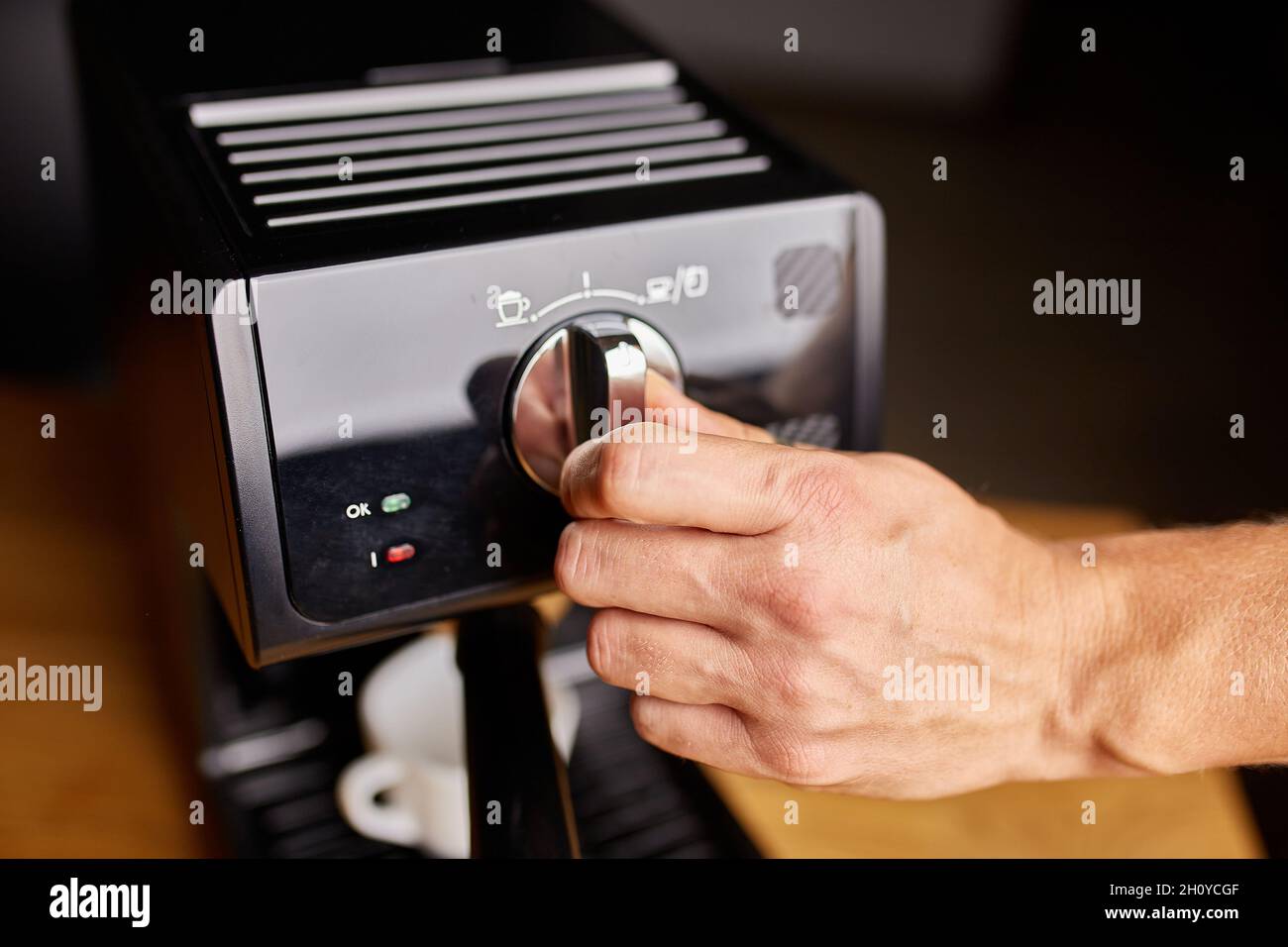 Female hands holding portafilter and making fresh aromatic coffee at ...