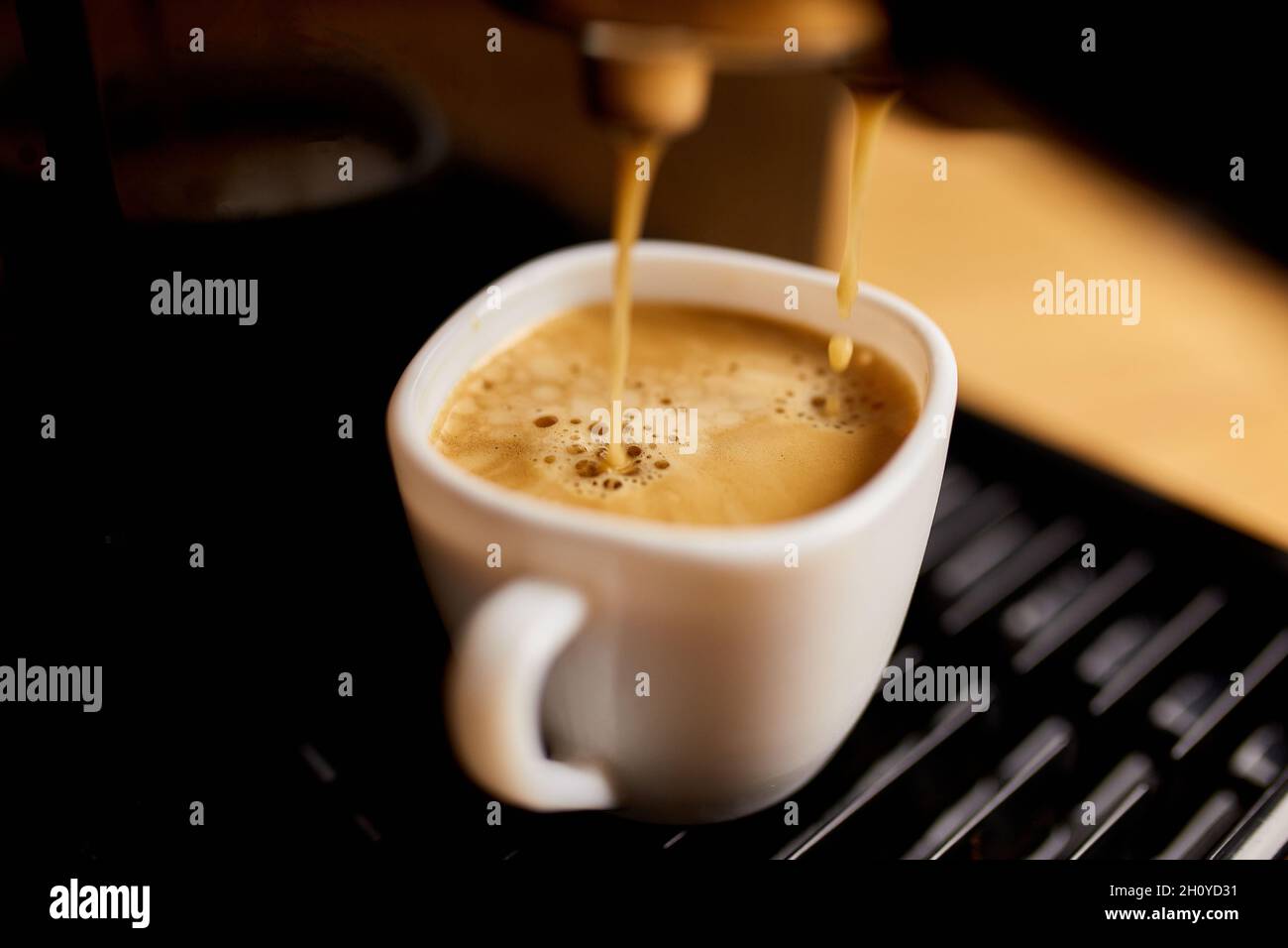 Detail of a professional coffe maker dripping coffe into an empty cup ...