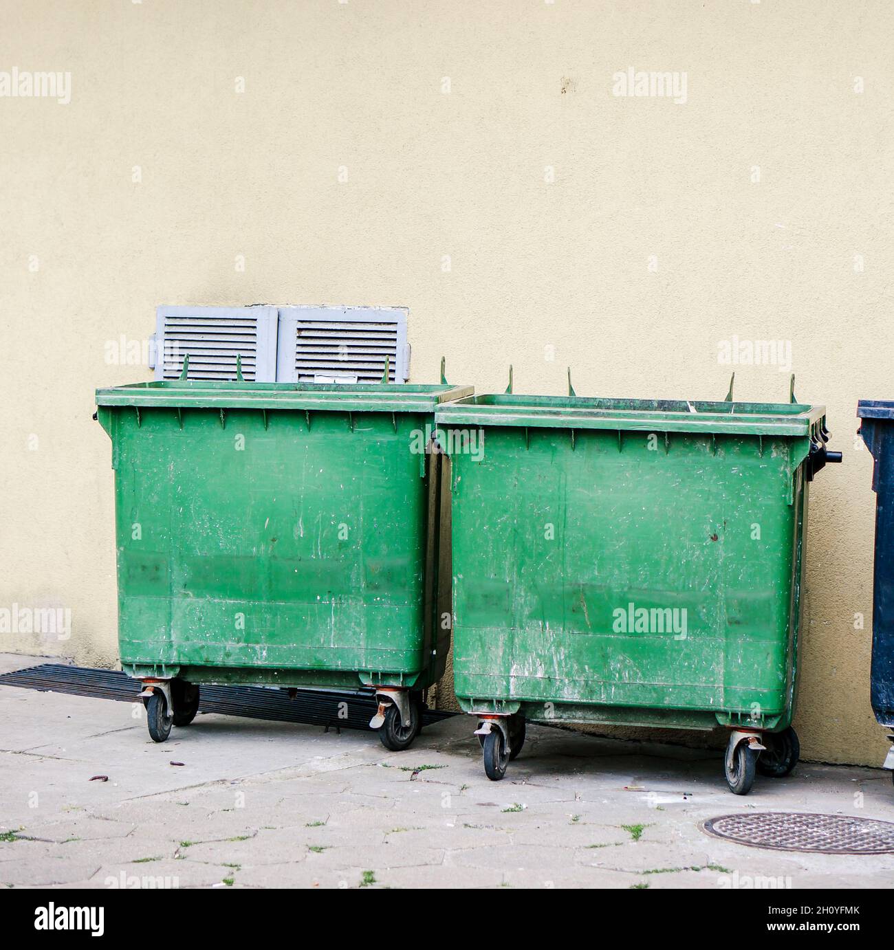 Green dirty plastic trash bins in the street Stock Photo - Alamy