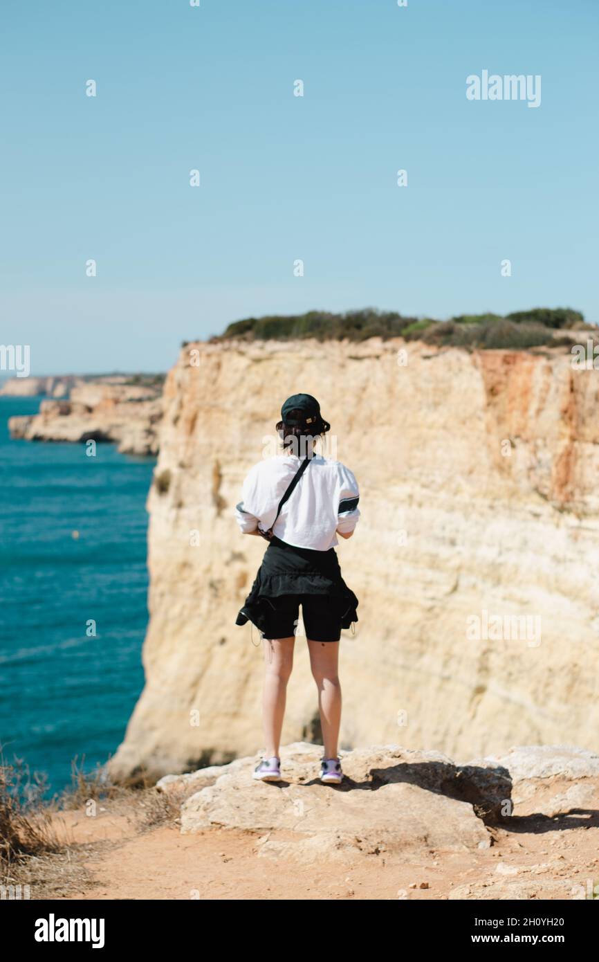 young girl posing on cliff Stock Photo - Alamy