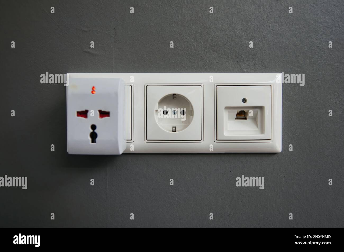 Front view of electricity power outlet with one RJ45 phone cable and ...