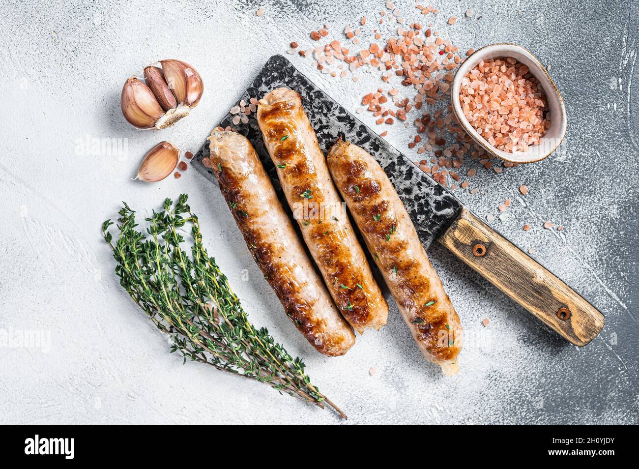 Grilled Bockwurst and Bratwurst meat sausages on a cleaver. White ...