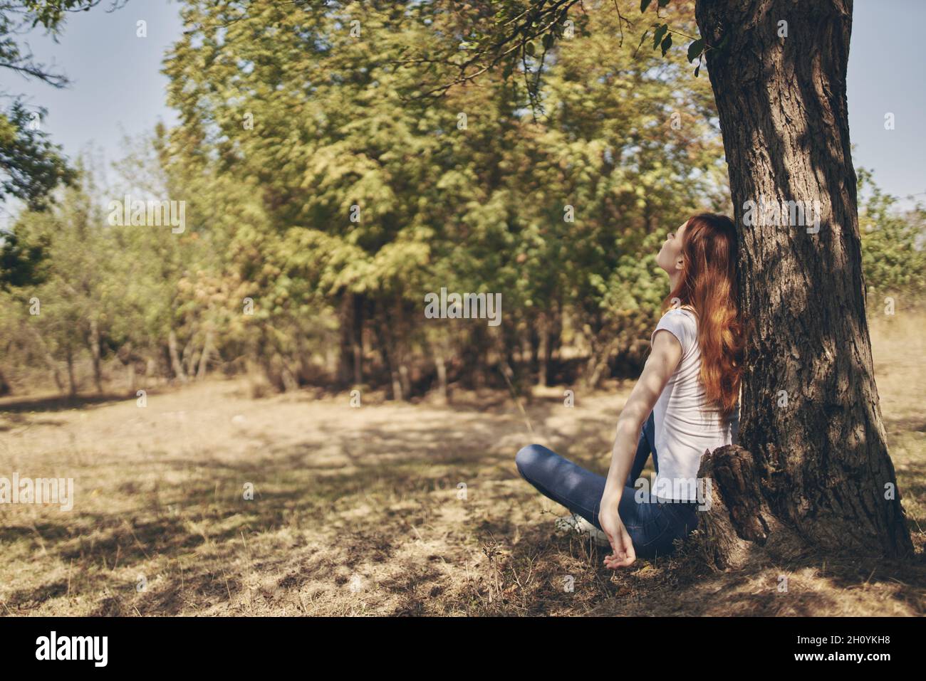 woman outdoors by the tree Sun freedom journey Stock Photo - Alamy