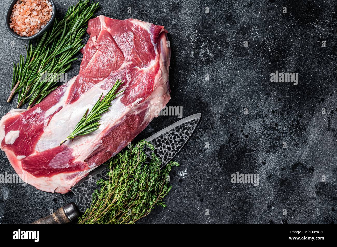 Fresh Raw lamb mutton shoulder meat with butcher knife. Black ...