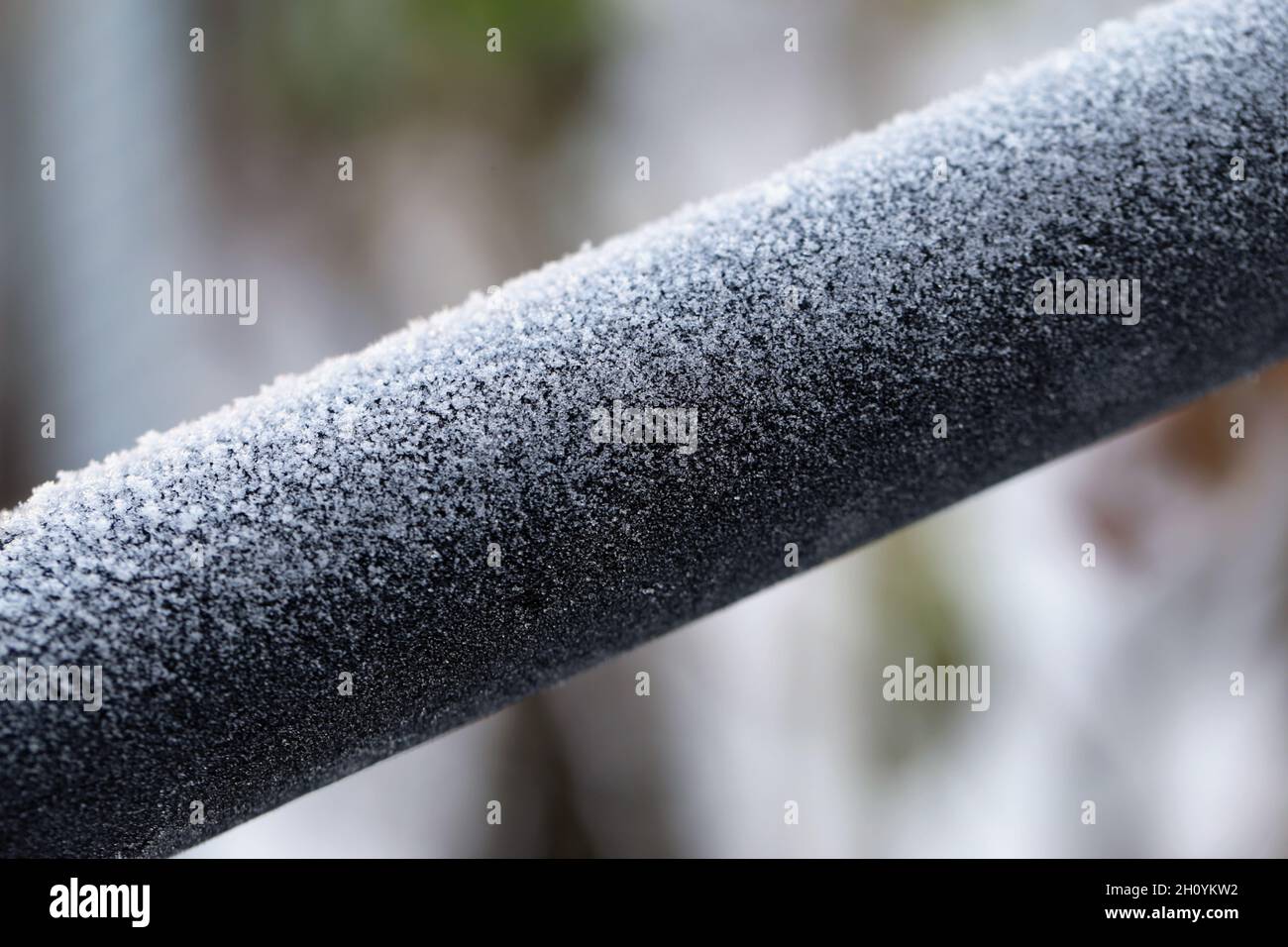 Hoarfrost on top a silver metal pipe. Frosted pipe was photographed in ...