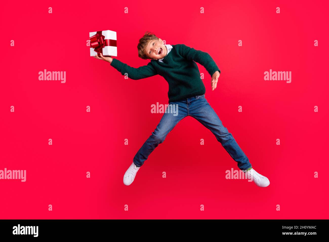 Photo of adorable pretty school boy wear knitted pullover smiling ...