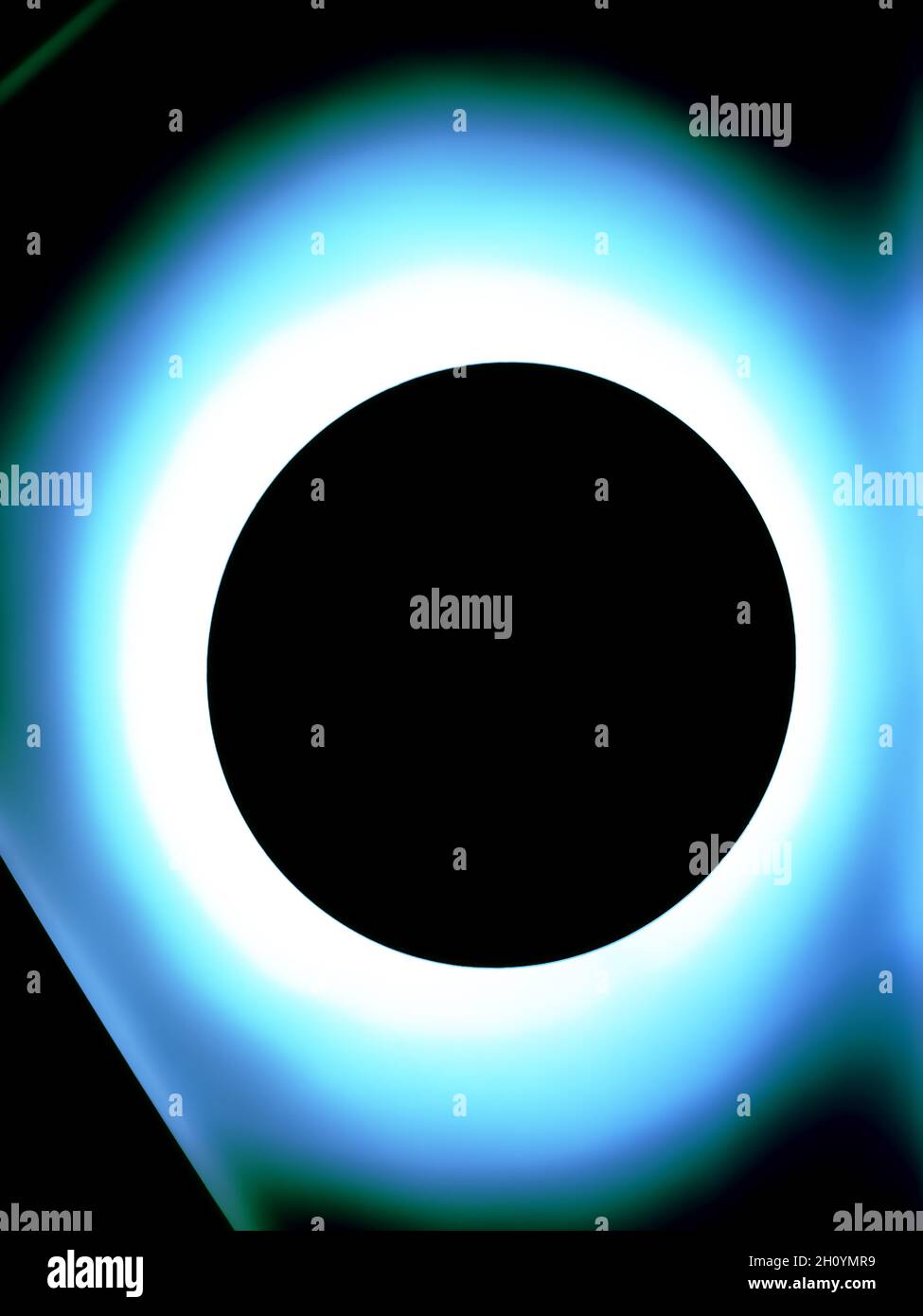 Illustration of a blue shiny circle in the middle of a black background ...