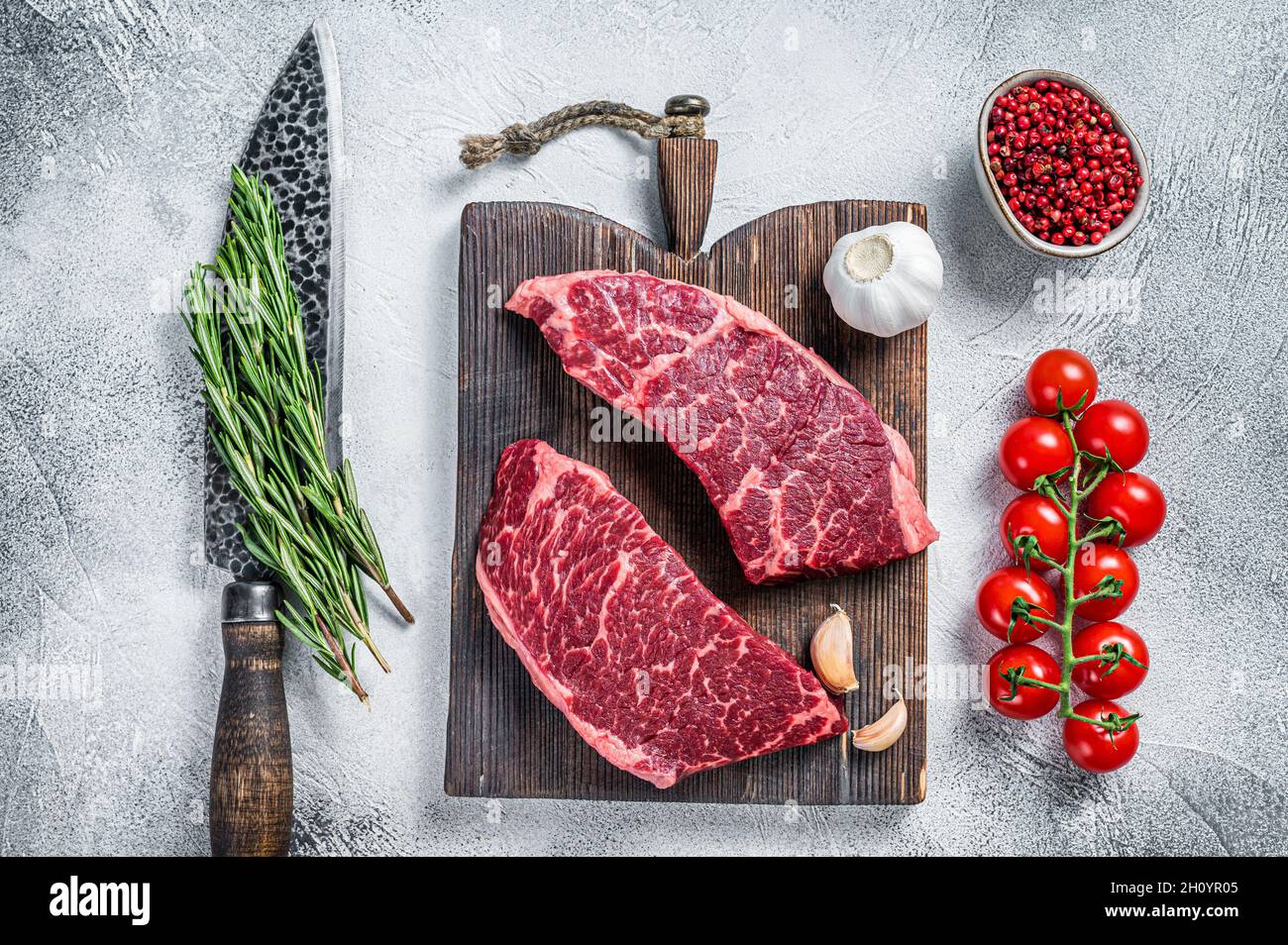 Raw denver cut black angus organic steak on a butcher cutting board ...