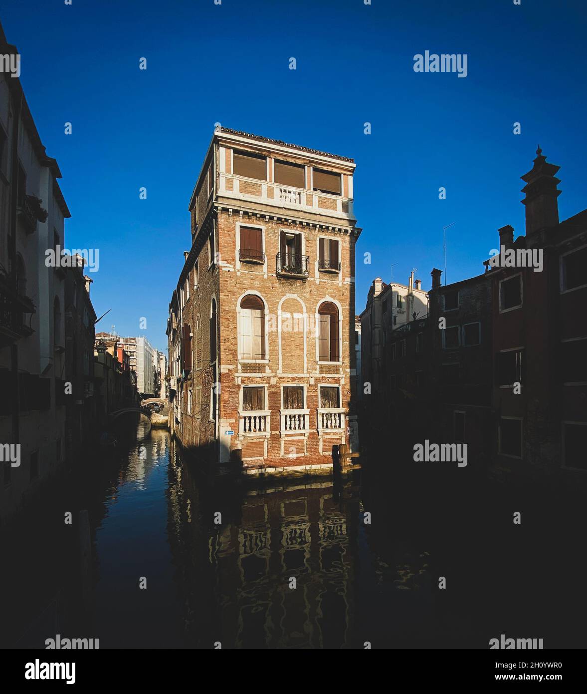 Beautiful and colorful venetian front house surrounded by water during ...