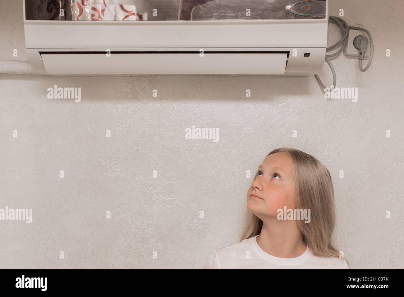 Young cute blonde girl teenager of European appearance stands under air ...