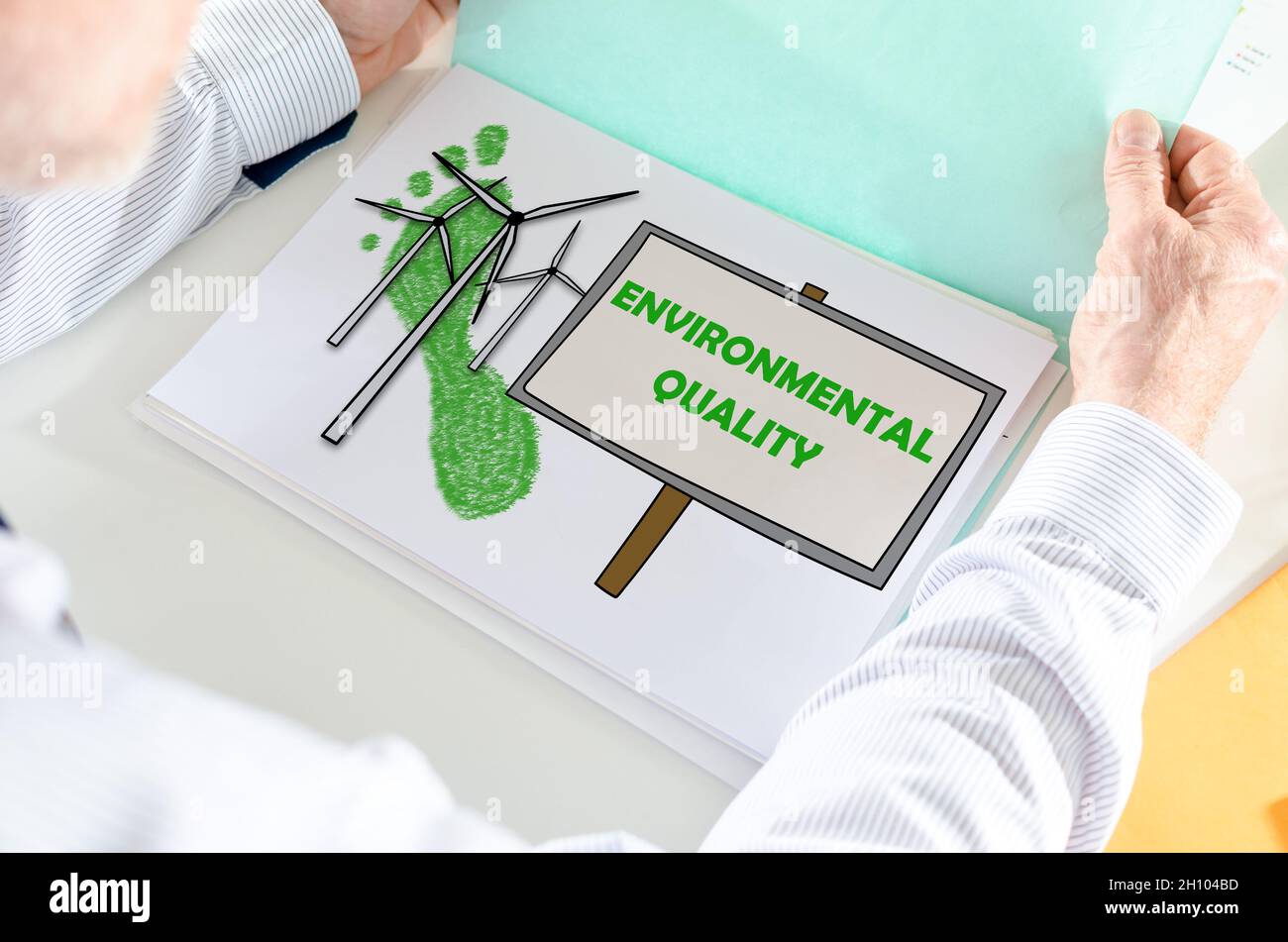 Man holding a file with environmental quality concept Stock Photo - Alamy