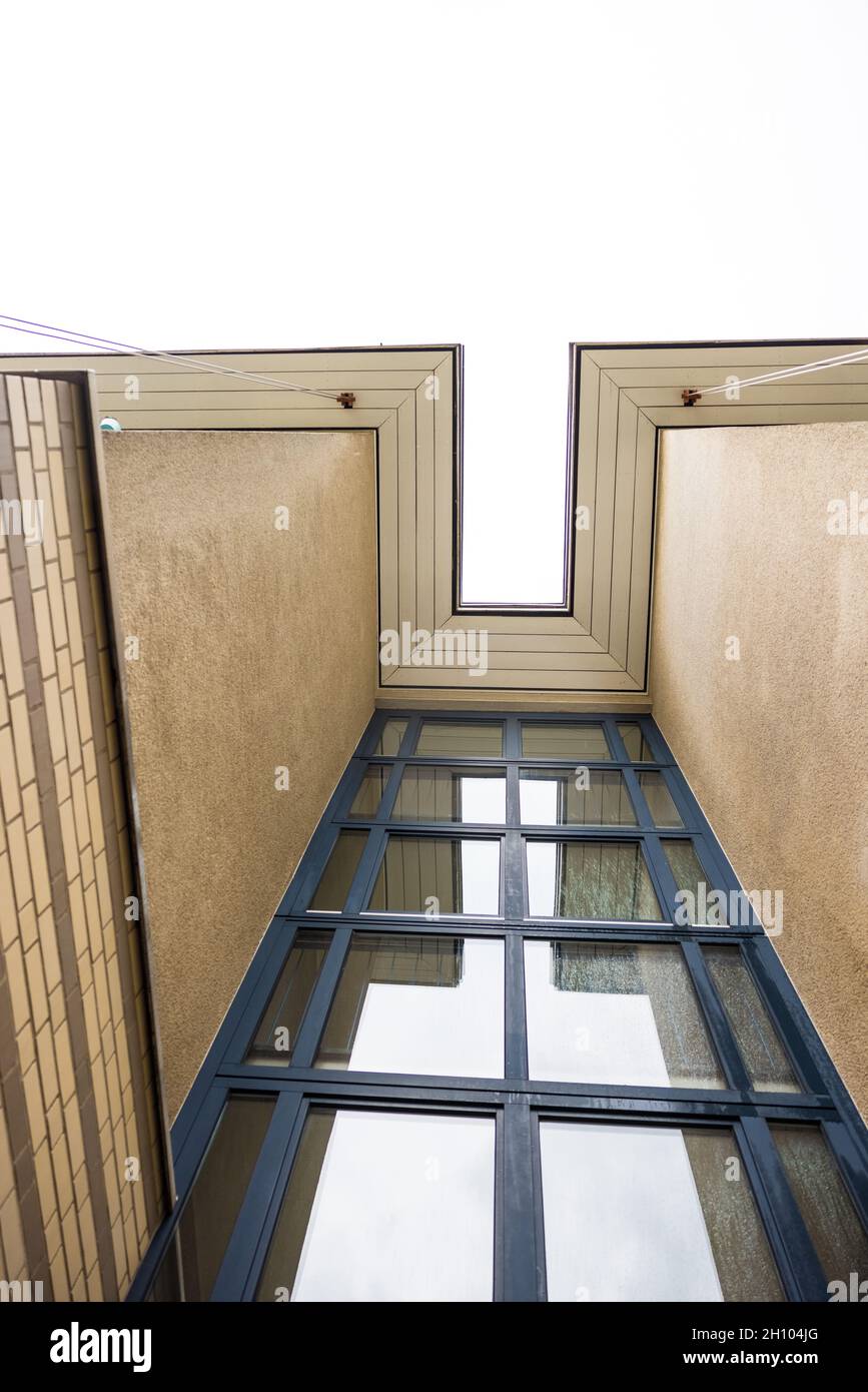Low-angle shot of an entrance glass door to a modern high-rise building ...